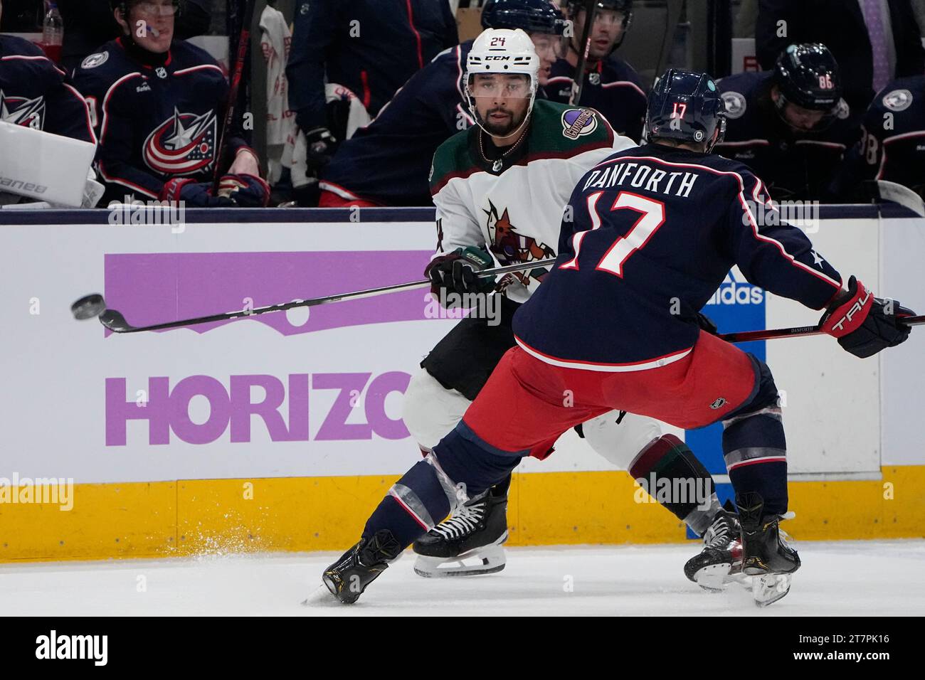 Arizona Coyotes defenseman Matt Dumba, rear, passes under pressure from ...
