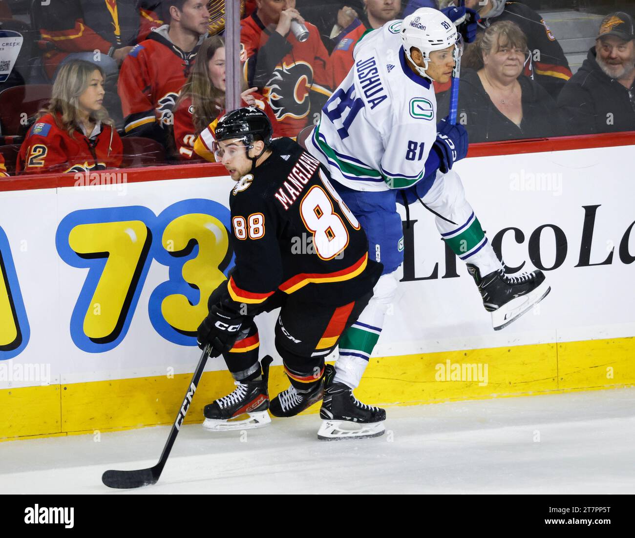 Vancouver Canucks forward Dakota Joshua, right, is checked by Calgary ...