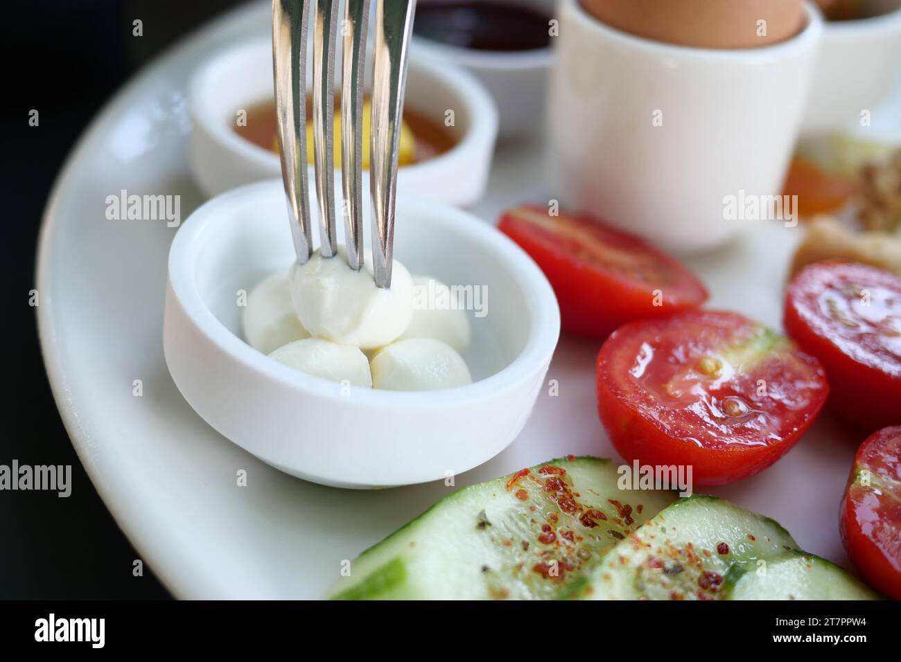 Many fresh white mozzarella cheese balls in container on a break fast ...