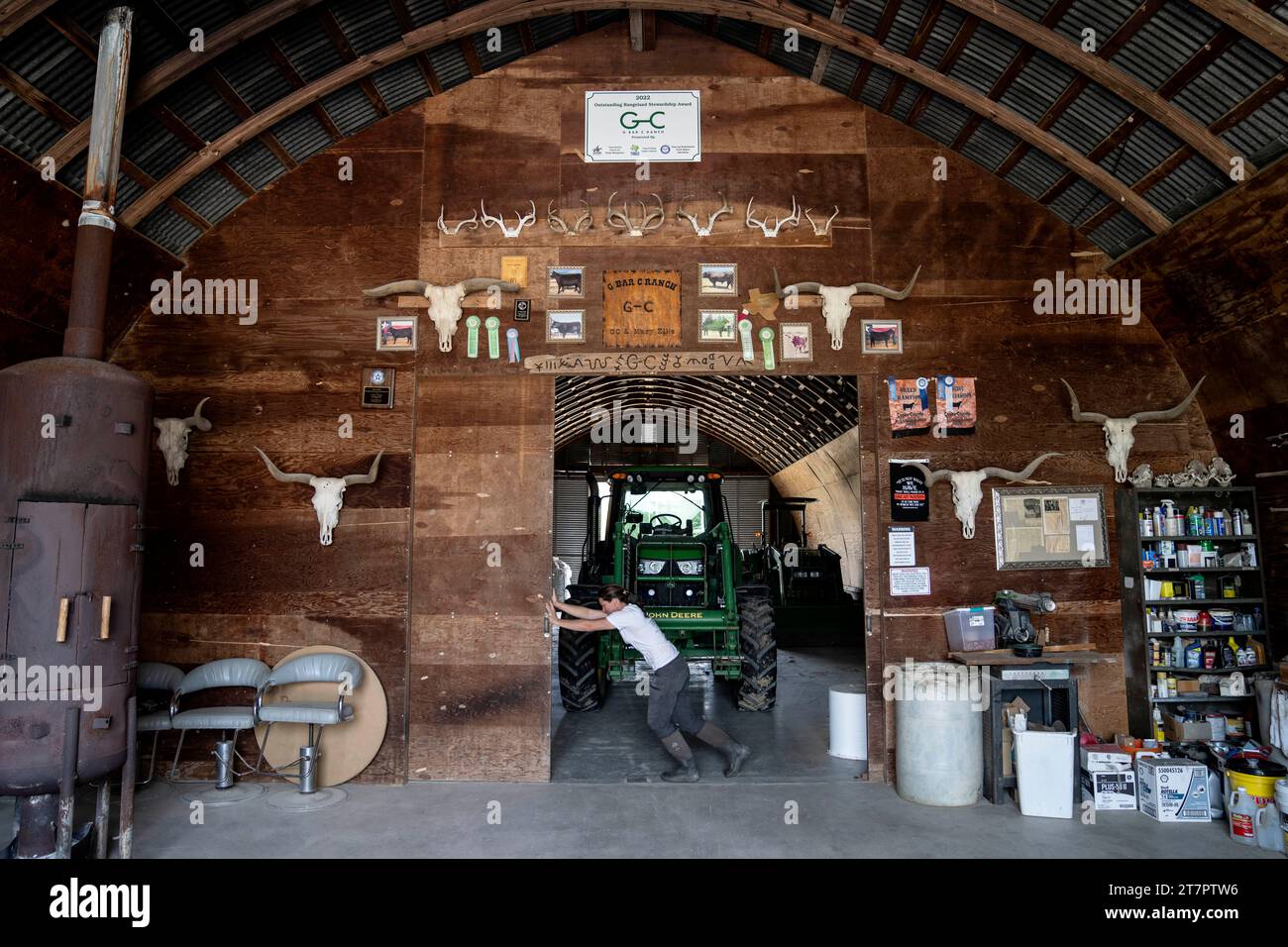 Meredith Ellis pushes open a barn door at her ranch in Rosston, Texas ...