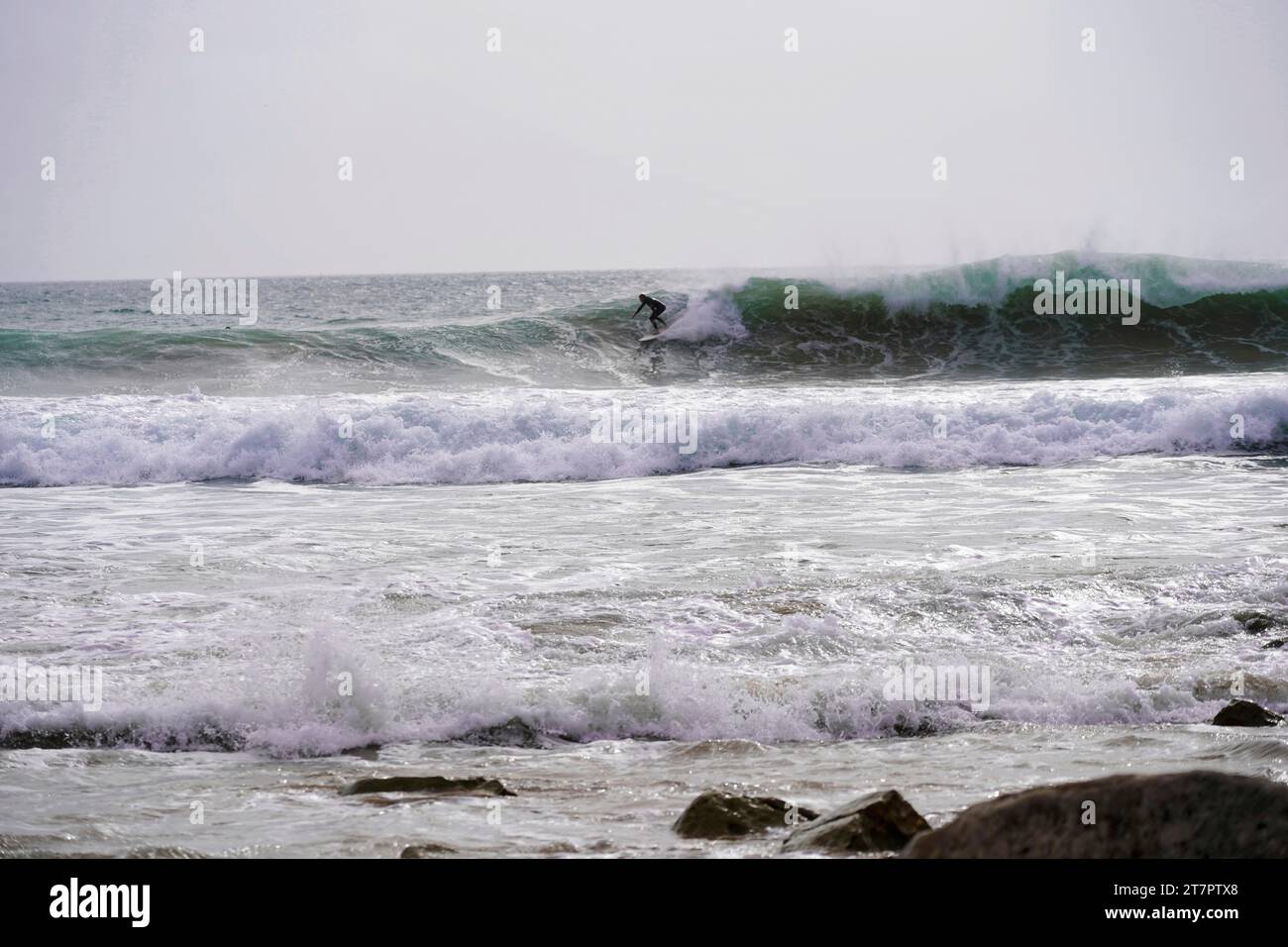 Surfers, surf at the beach in Praia do Burgau, Faro district, Algarve ...