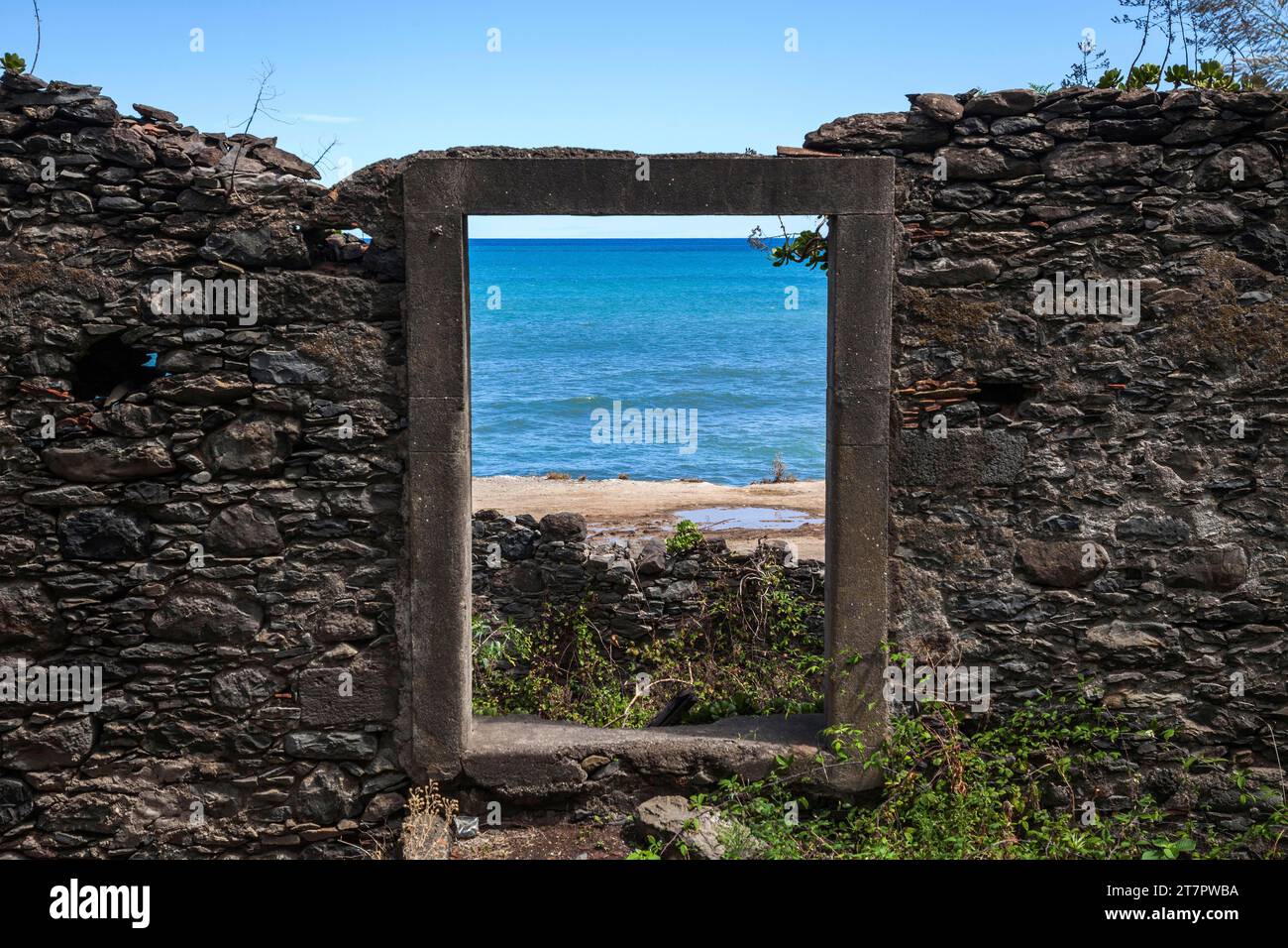 Crumbling wall with window frame, view to the sea, Porto da Cruz ...