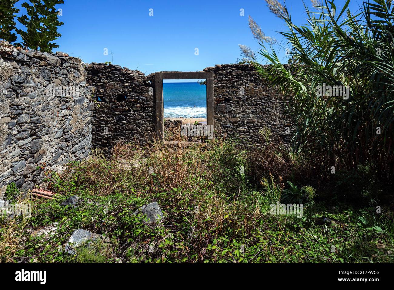 Crumbling wall with window frame, view to the sea, Porto da Cruz ...
