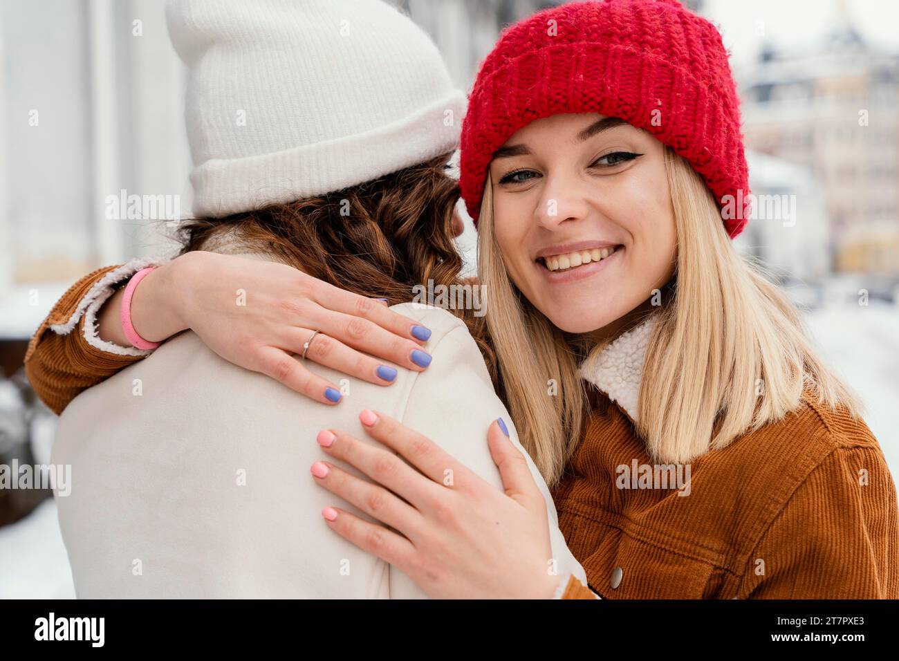 Young girlfriends hugging 2 Stock Photo - Alamy