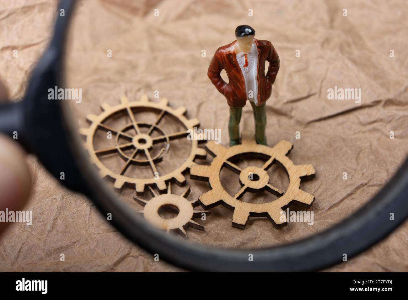 Little tiny man person figurine and gear wheel as industry concept ...