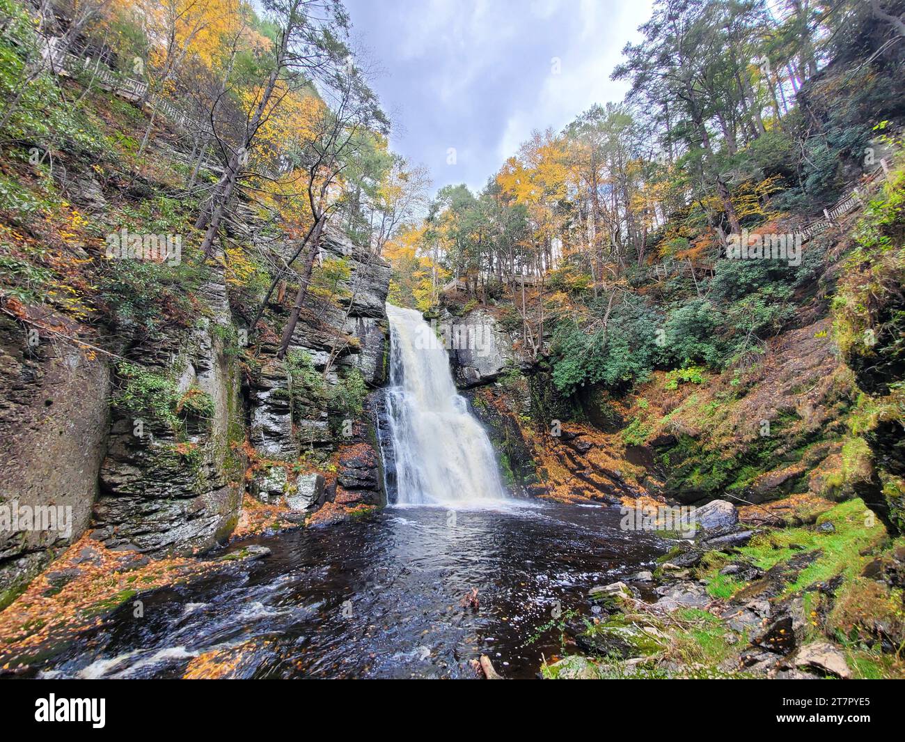 Beautiful view of the main waterfall surrounded by stunning fall foliage near Bushkill Falls ...