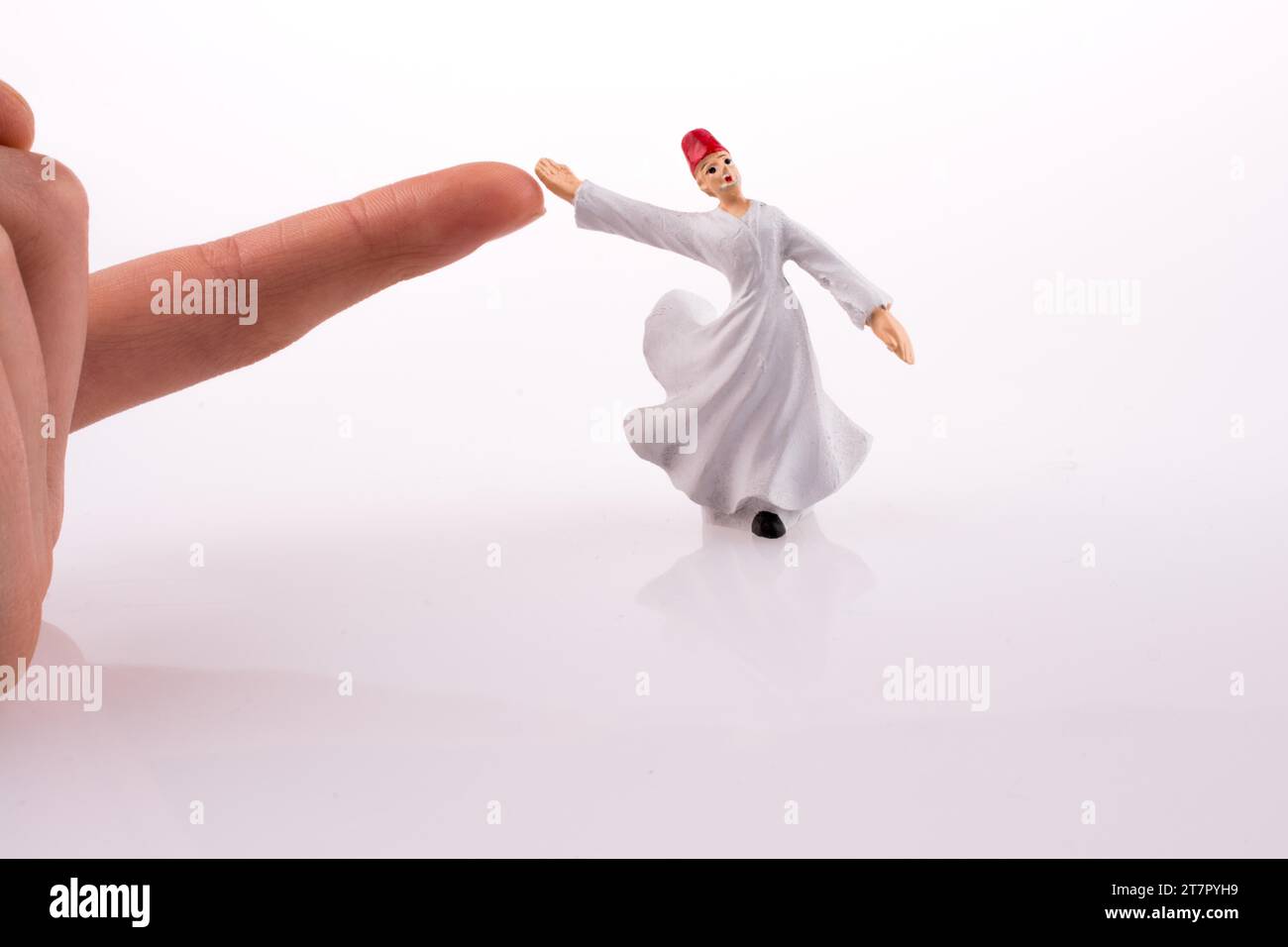 Hand holding a Sufi Dervis on a white background Stock Photo - Alamy