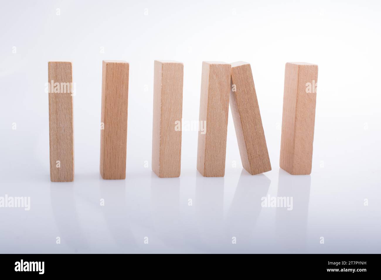 Wooden Domino Blocks in a line on a white background Stock Photo - Alamy