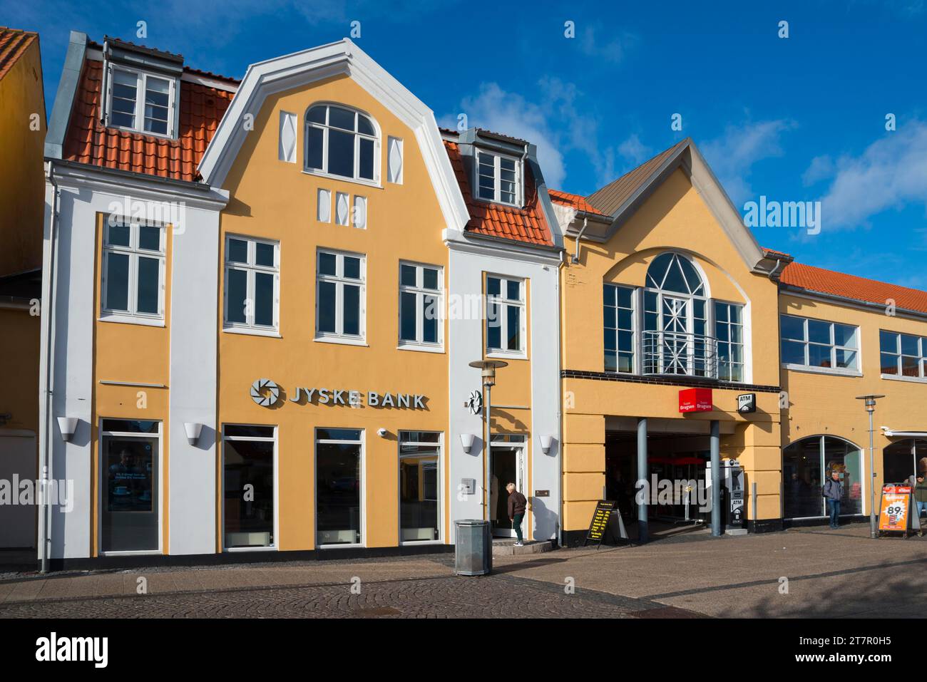 Danish bank in the city centre and typical yellow houses, Skagen, North ...