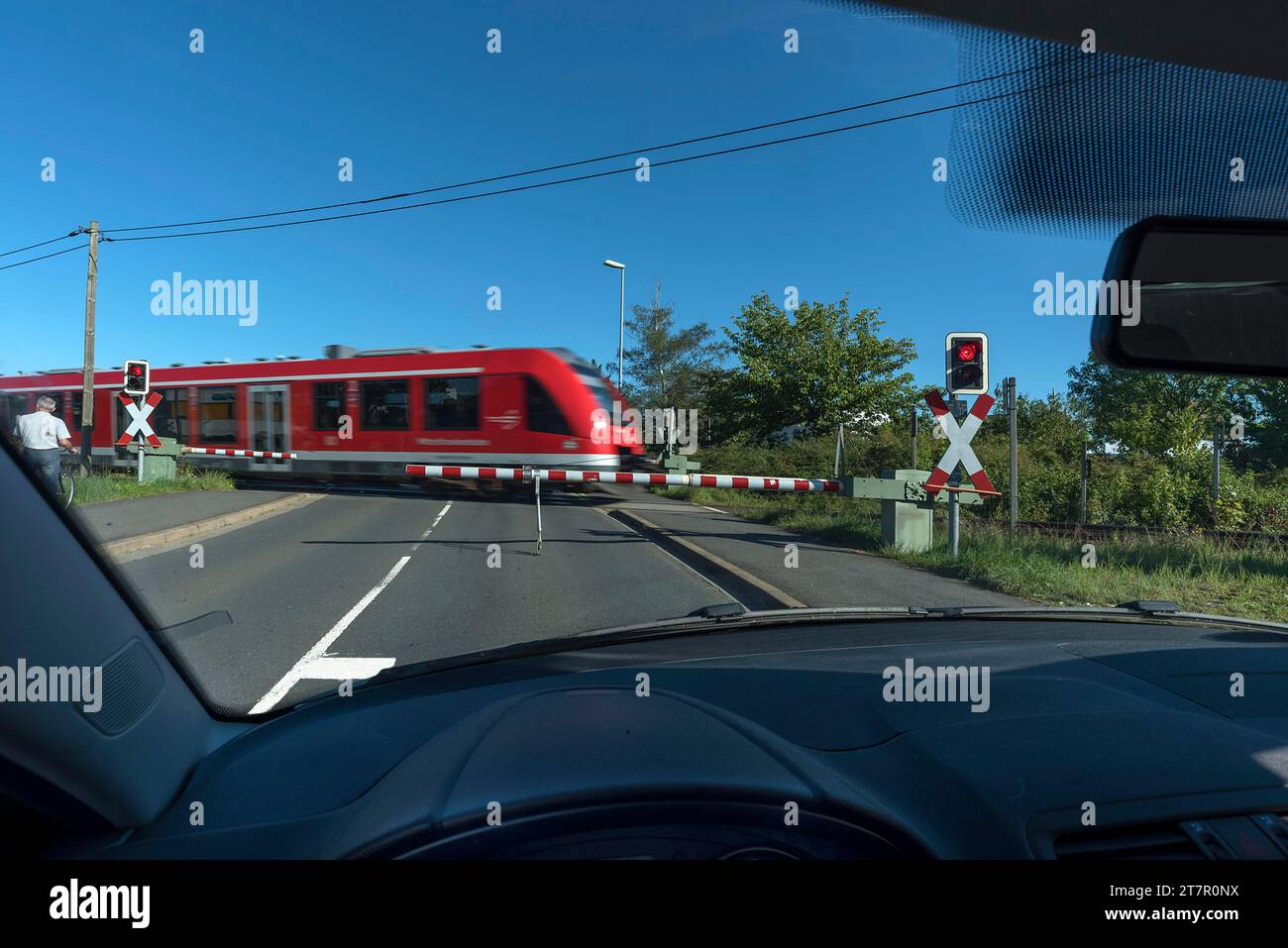View from a car of the passing railway at a level crossing with ...