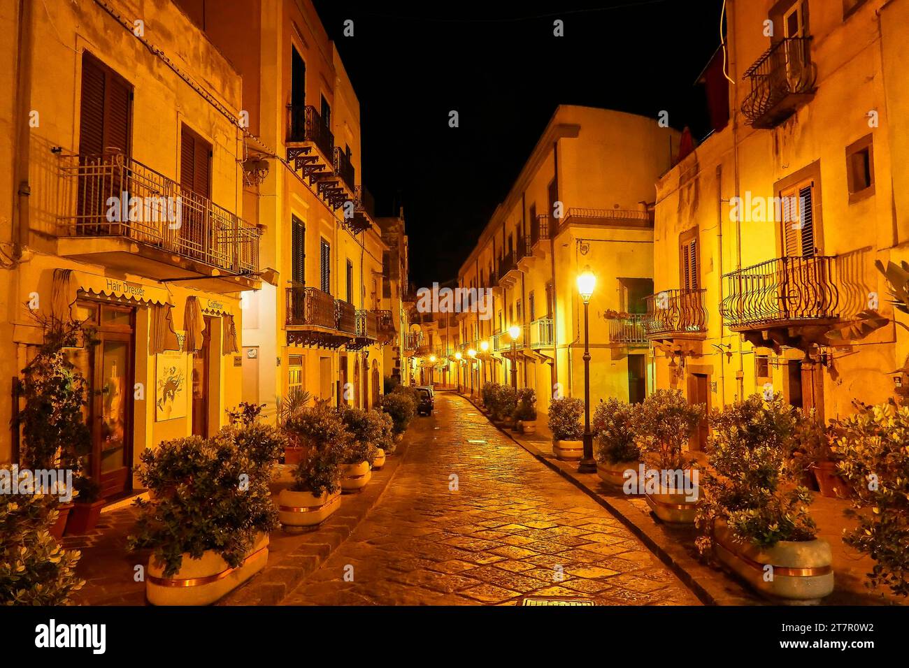 Night shot, cobbled street at night, deserted, lanterns, planters ...