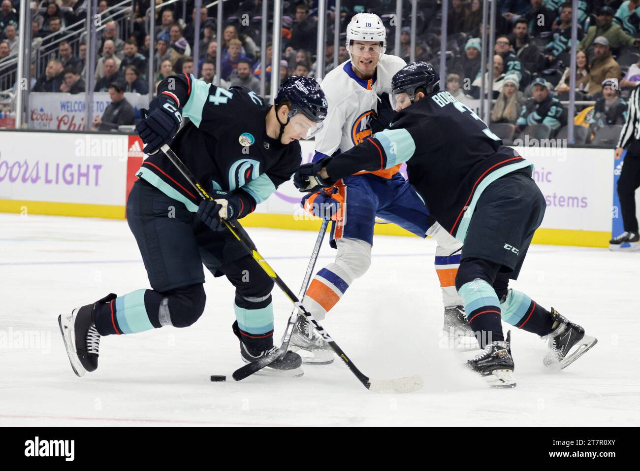 New York Islanders left wing Pierre Engvall, center, and Seattle Kraken ...