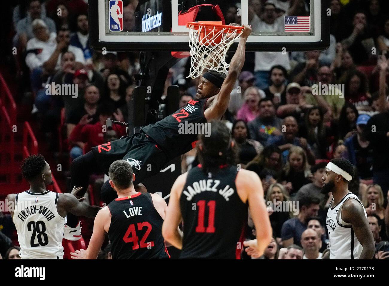 Miami Heat forward Jimmy Butler (22) swings from the rim after dunking ...