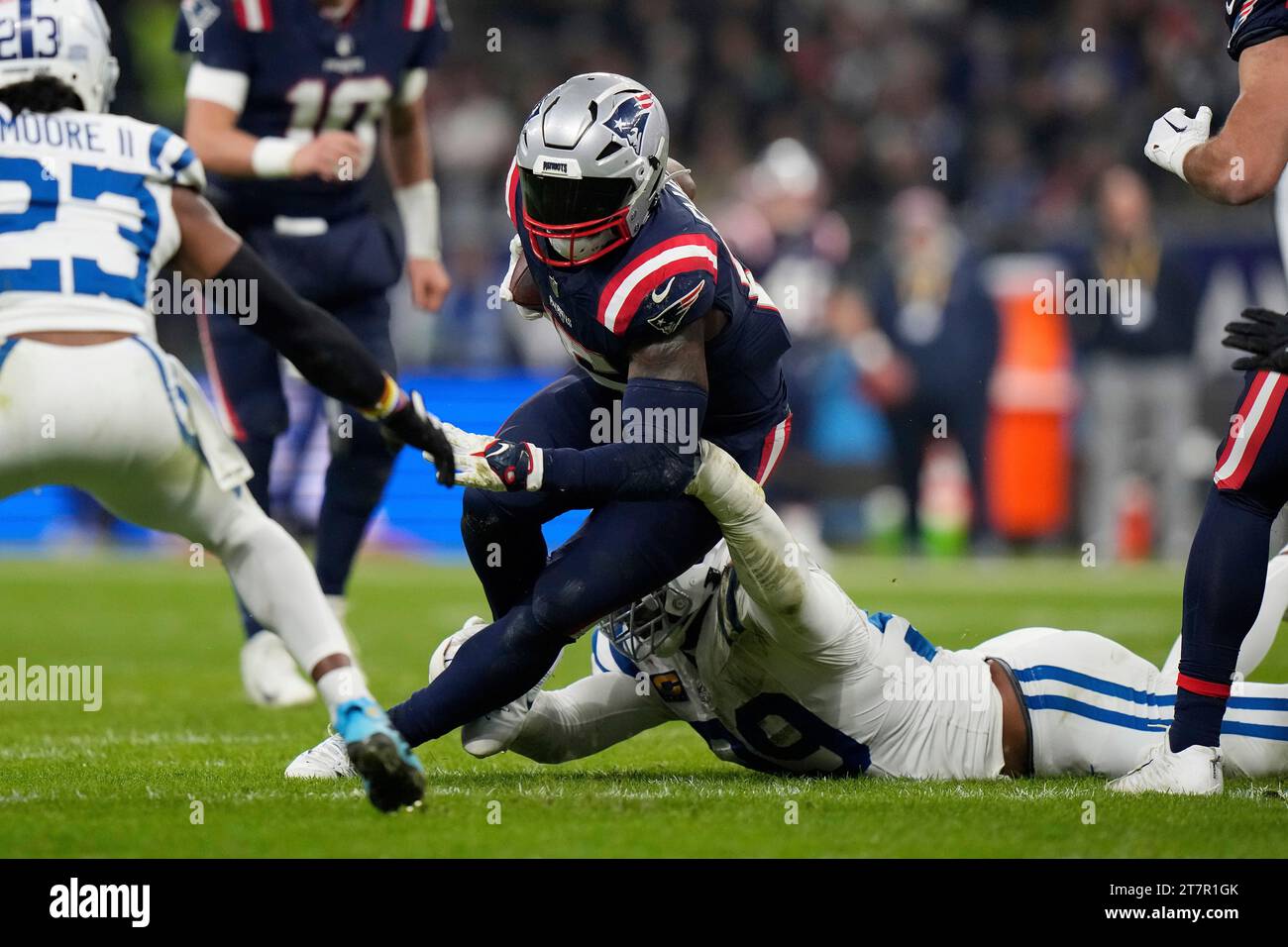 New England Patriots running back Ezekiel Elliott (15) is brought down ...