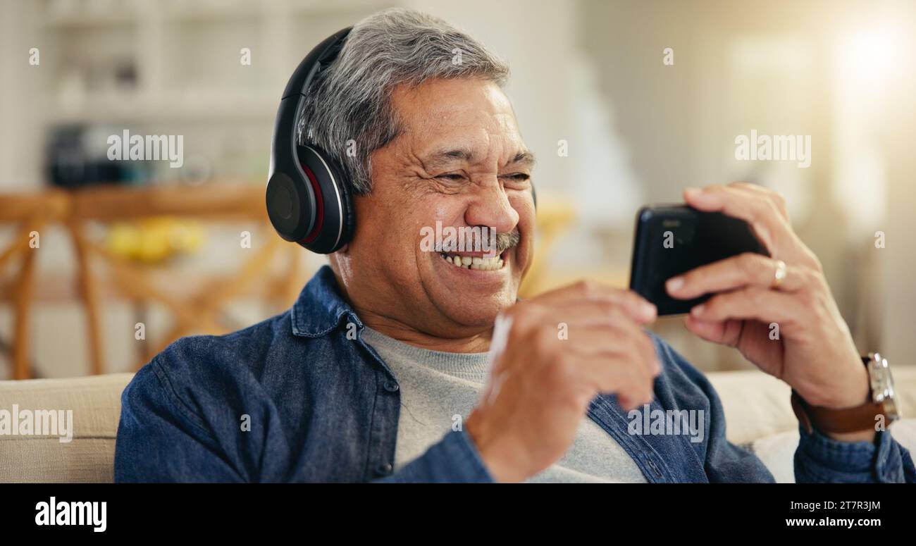 Senior, man and headphone with phone in home for streaming, online and ...