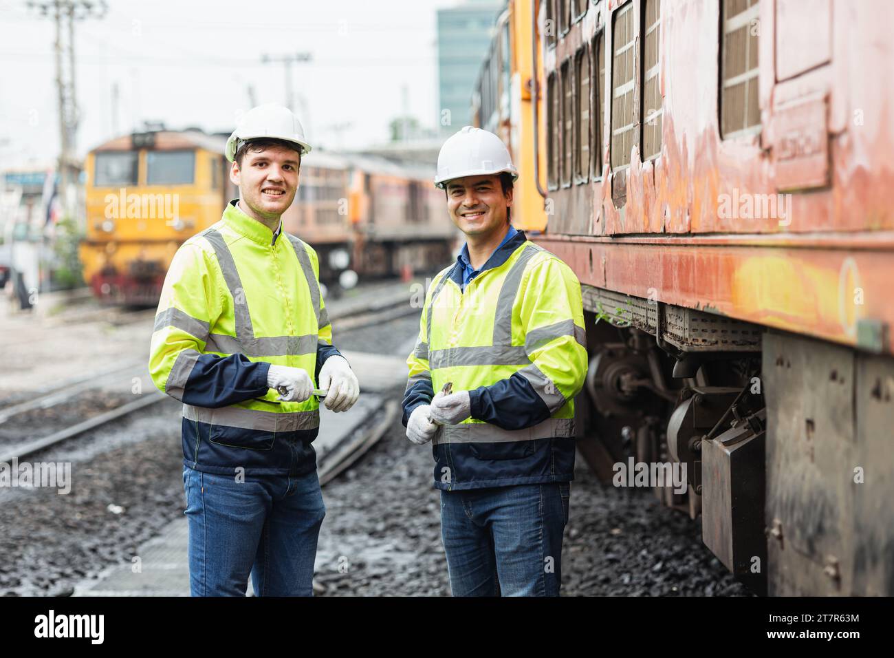 portrait engineer train service team with old broken diesel train park ...