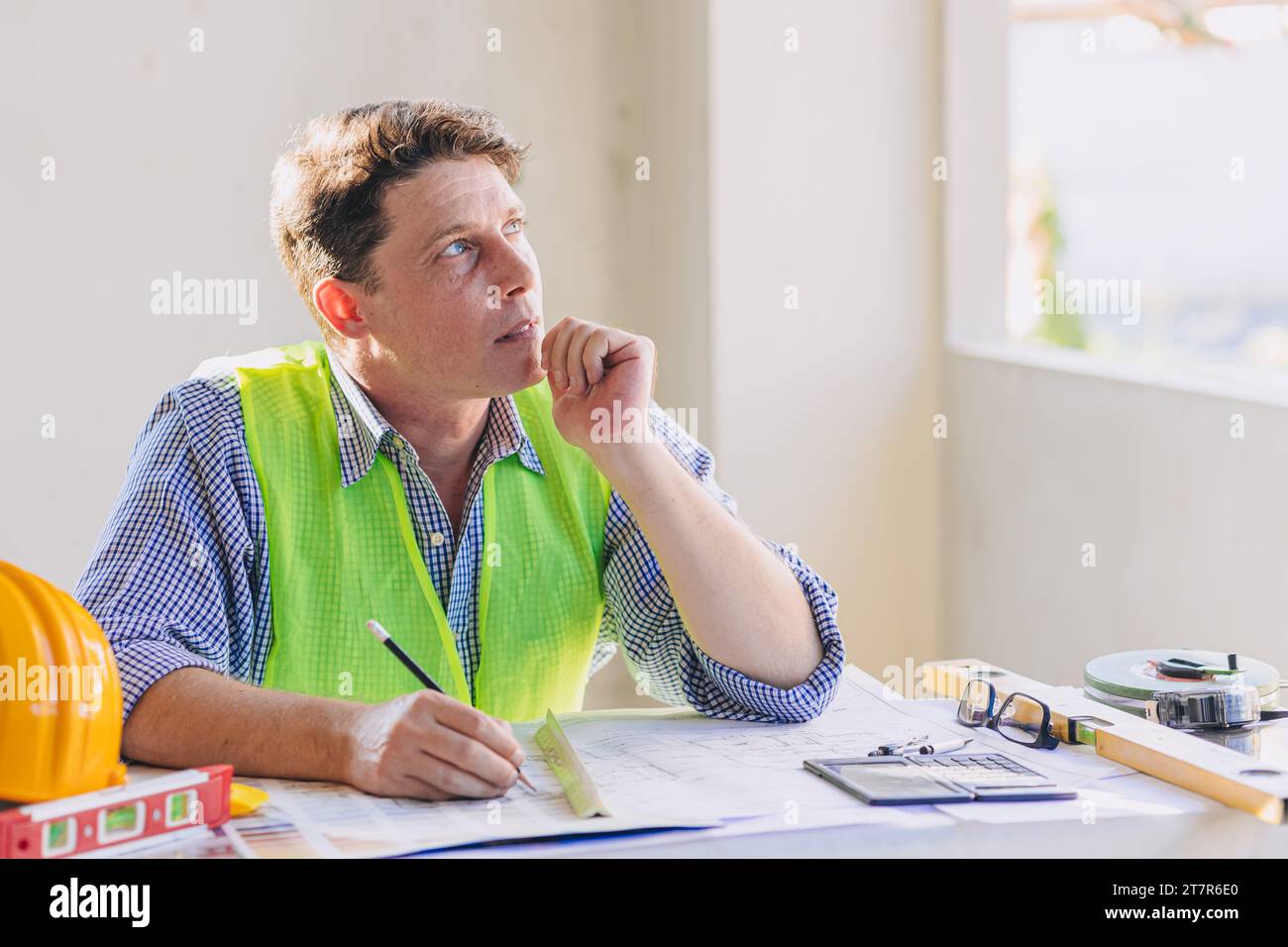 Thinking caucasian construction engineer builder architect building ... Thinking caucasian construction engineer builder architect building ...