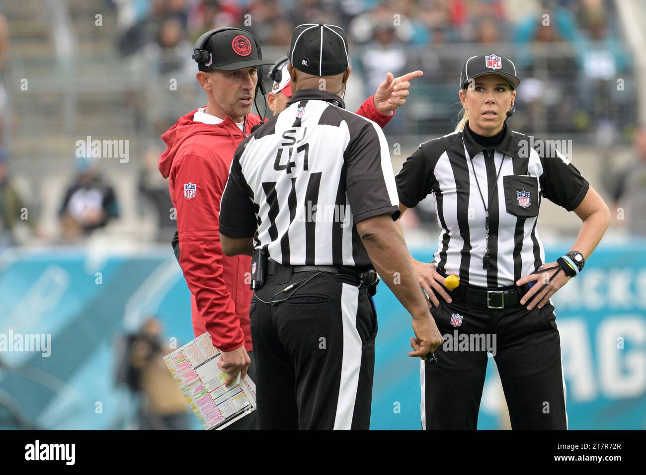 San Francisco 49ers head coach Kyle Shanahan, left, talks to side judge ...