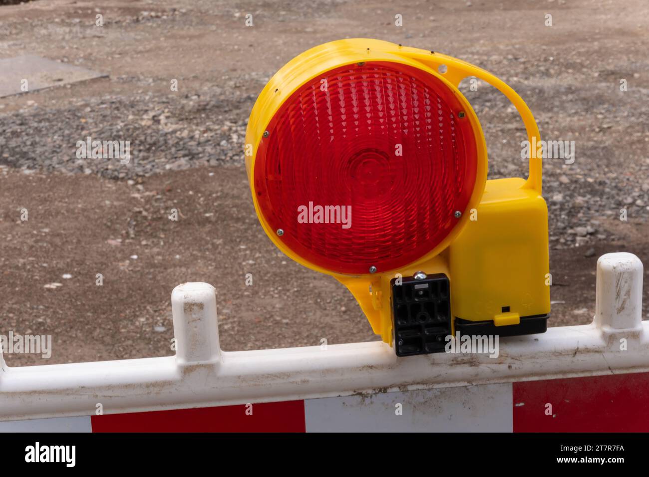 Close-up of a red warning light with street barriers at a construction ...
