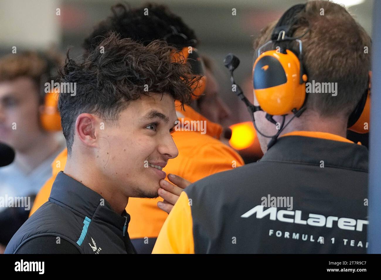 McLaren driver Lando Norris, of Britain, talks with team members after ...