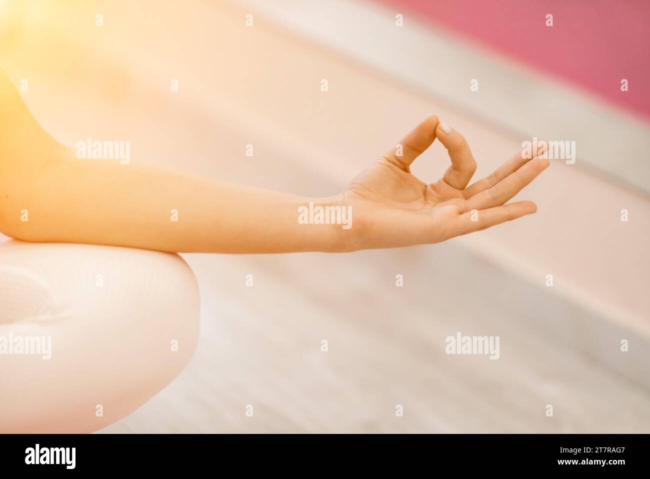 Girl does yoga. Young woman practices asanas on a beige one-ton ...
