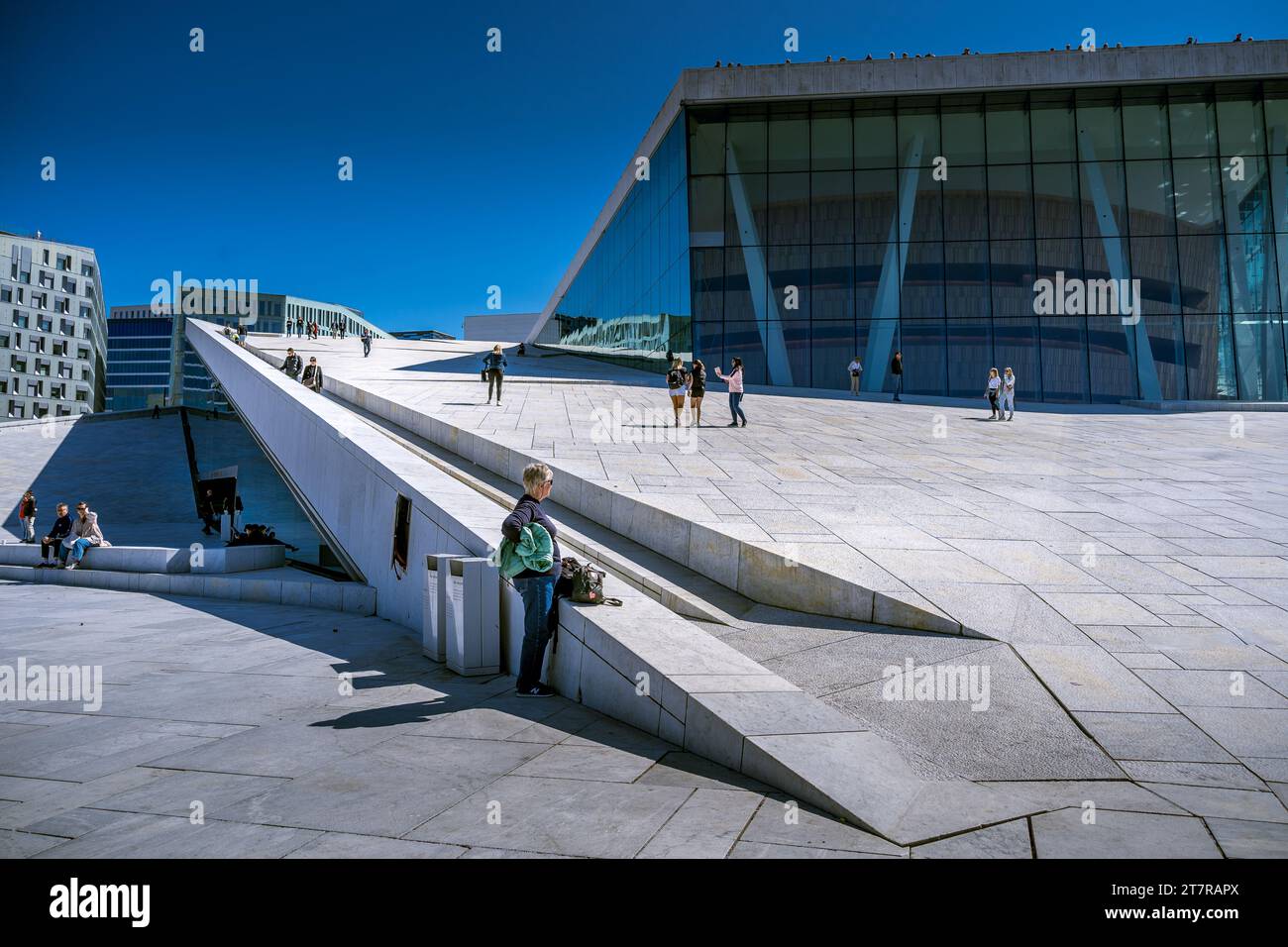 Visitors crossing the square of the Oslo Opera House Stock Photo - Alamy