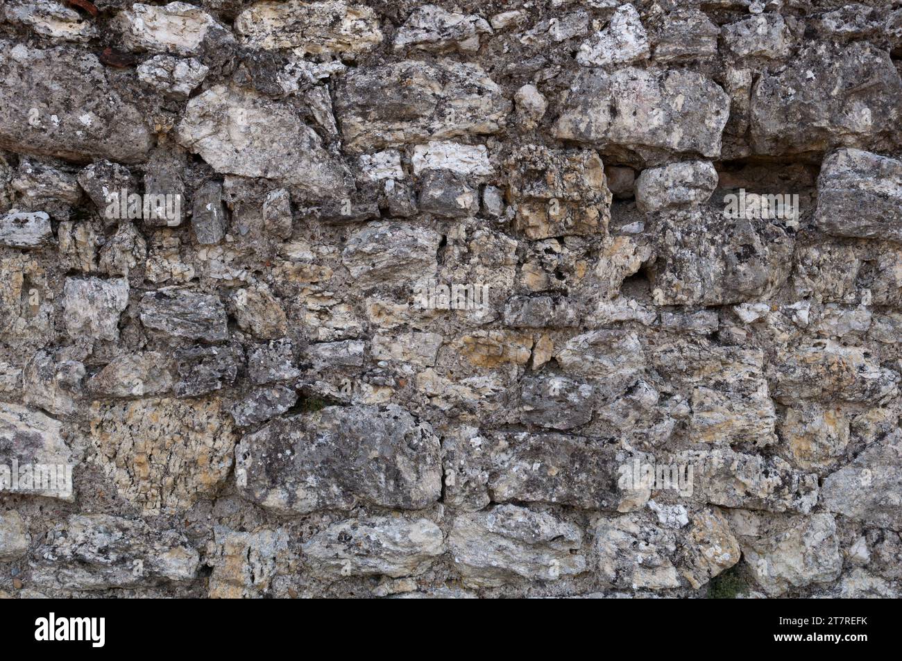 A semantically constructed stone wall with an array of cracks and ...