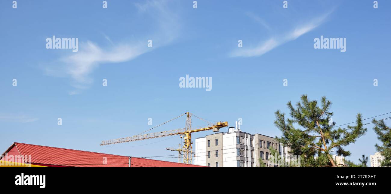 Fragment of tower crane, building a house. Concrete building under ...