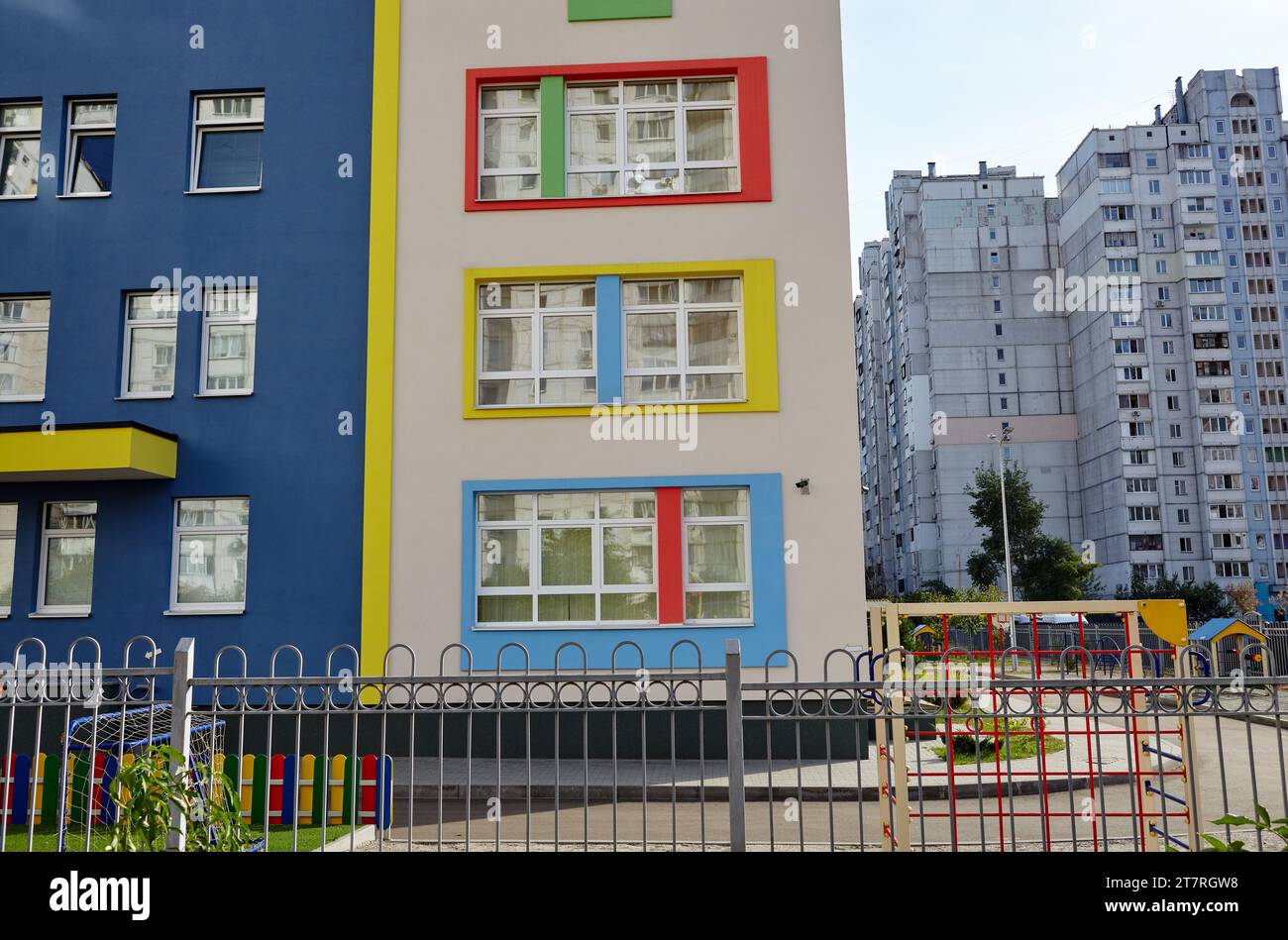 Facade of kindergarten building. Colorful playground for childrens on a ...