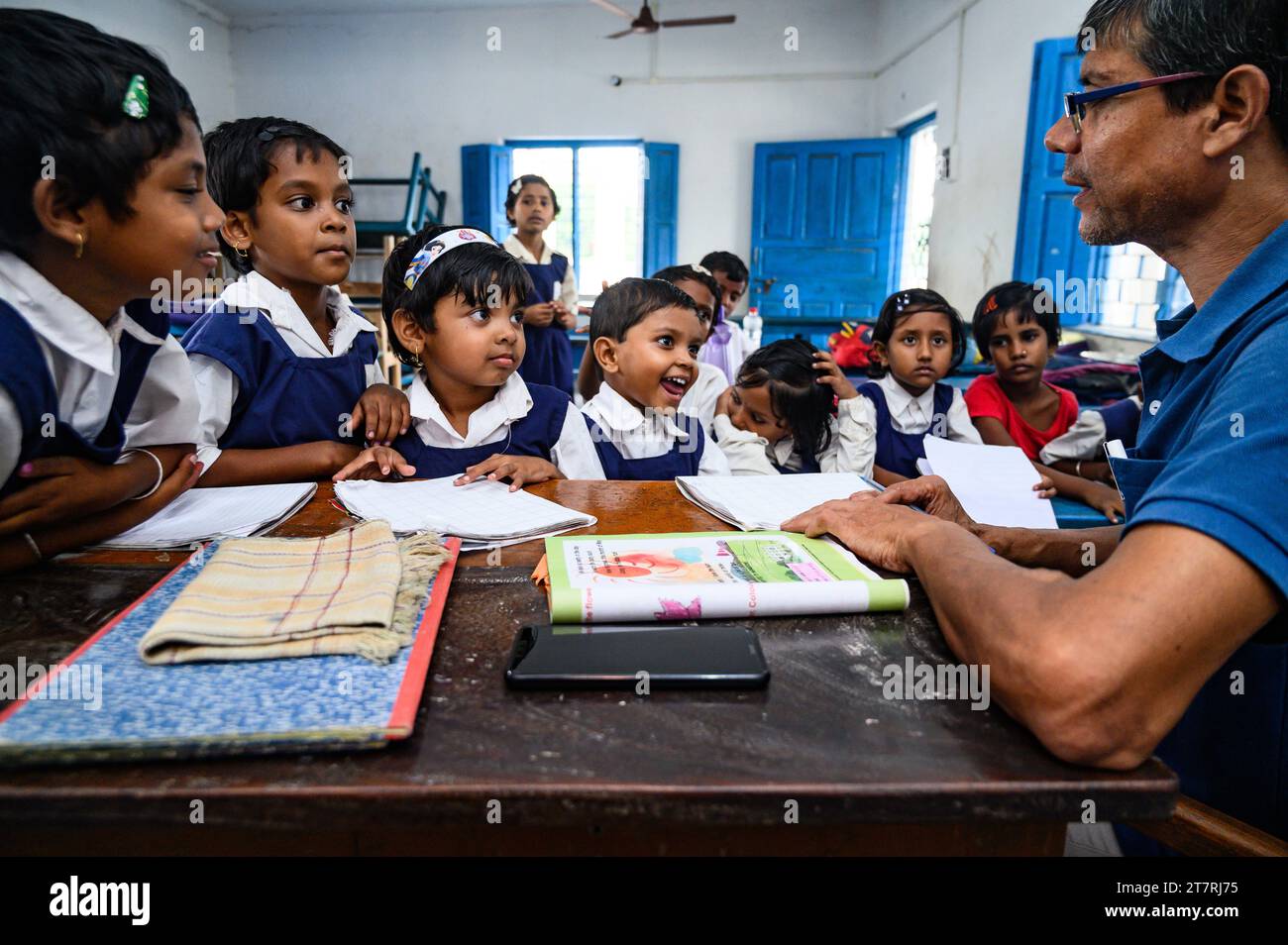 At a rural school on the India- Bangladesh border side, a teacher is ...