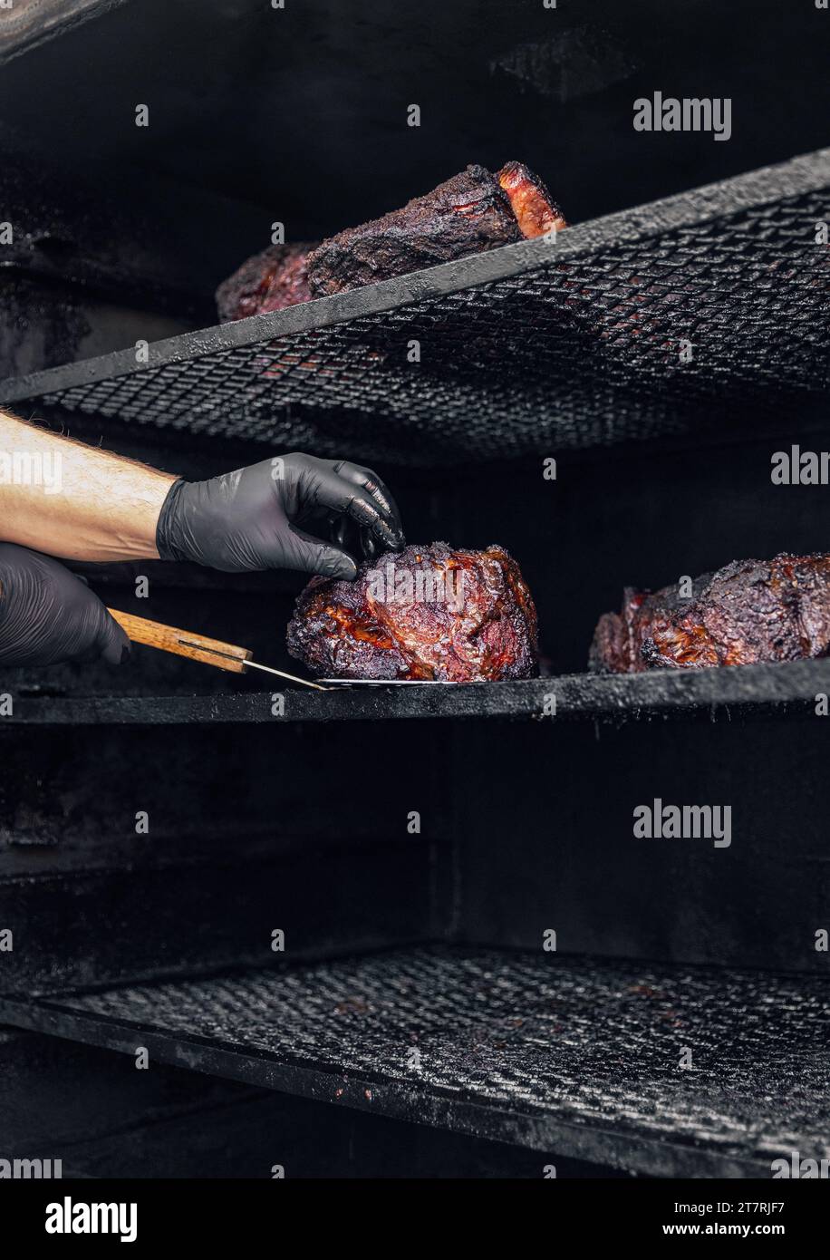 Large barbeque smoker grill. Meat prepared in barbecue smoker Stock ...