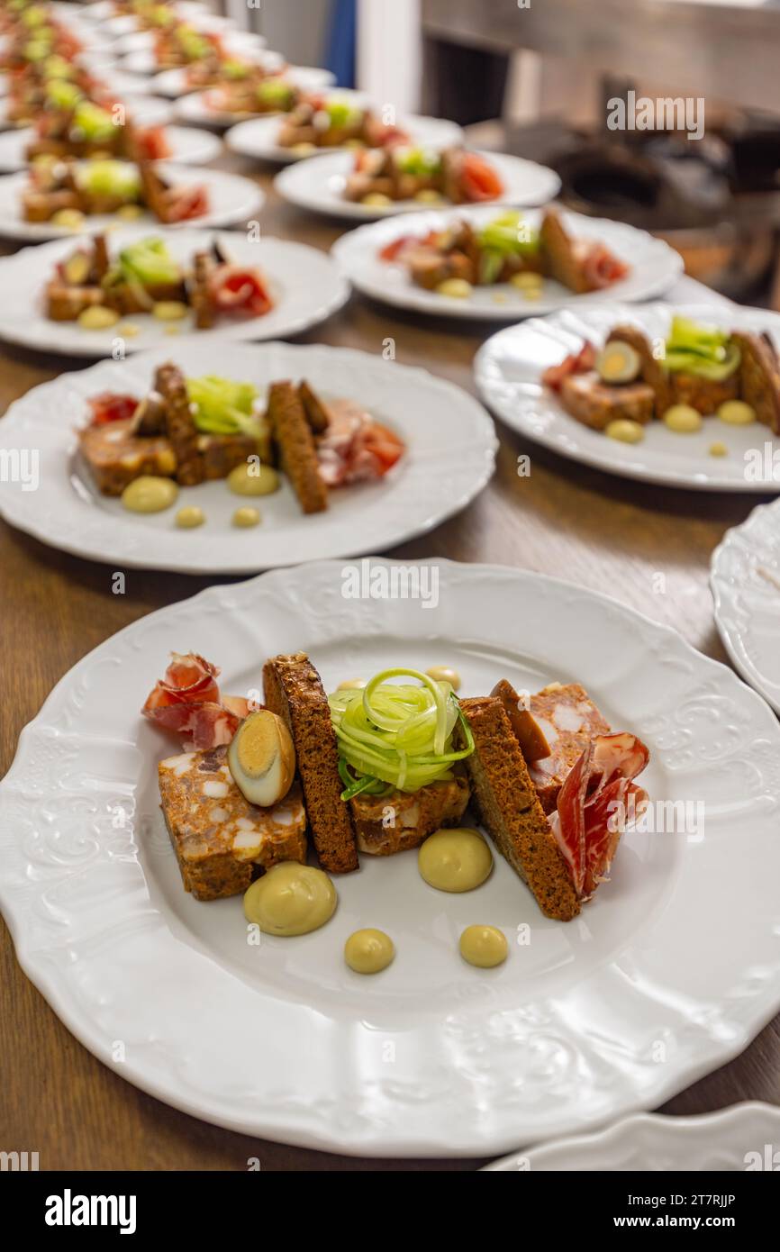Catering concept, many plates on restaurant kitchen counter arranged ...