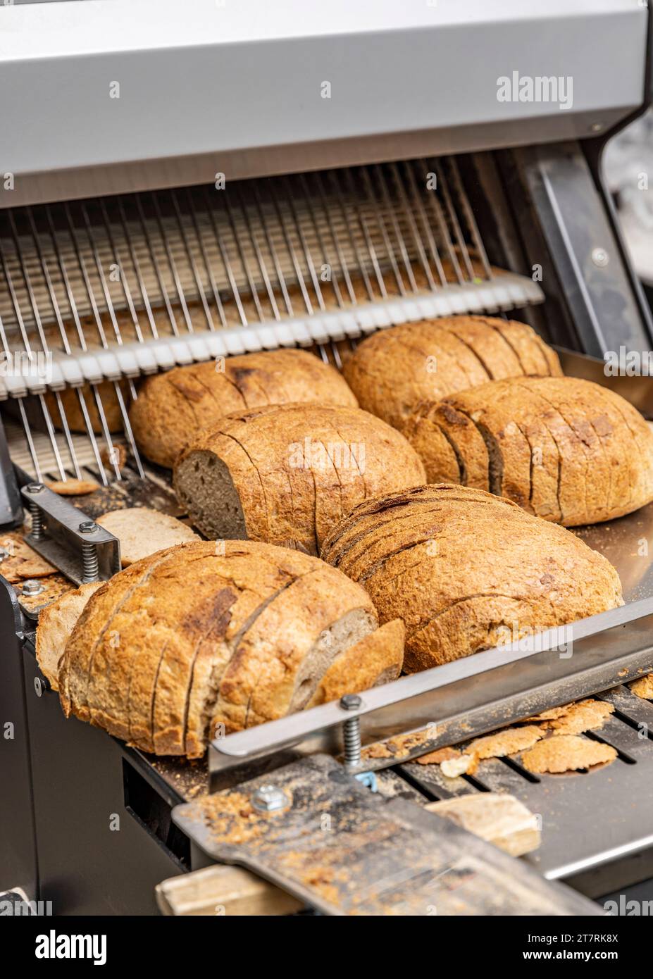 Sourdough bread slicing in industrial bread slicing machine in bread ...