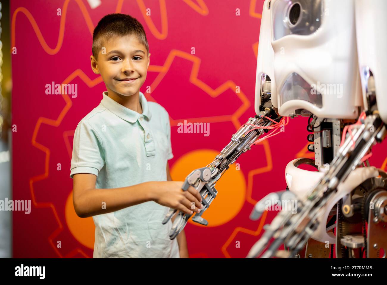 Boy shaking hands with a humanoid robot in mueum Stock Photo - Alamy