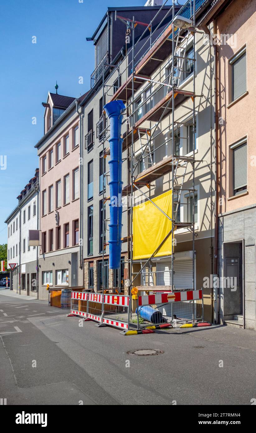 Building site at a house facade with scaffolding in sunny ambiance ...