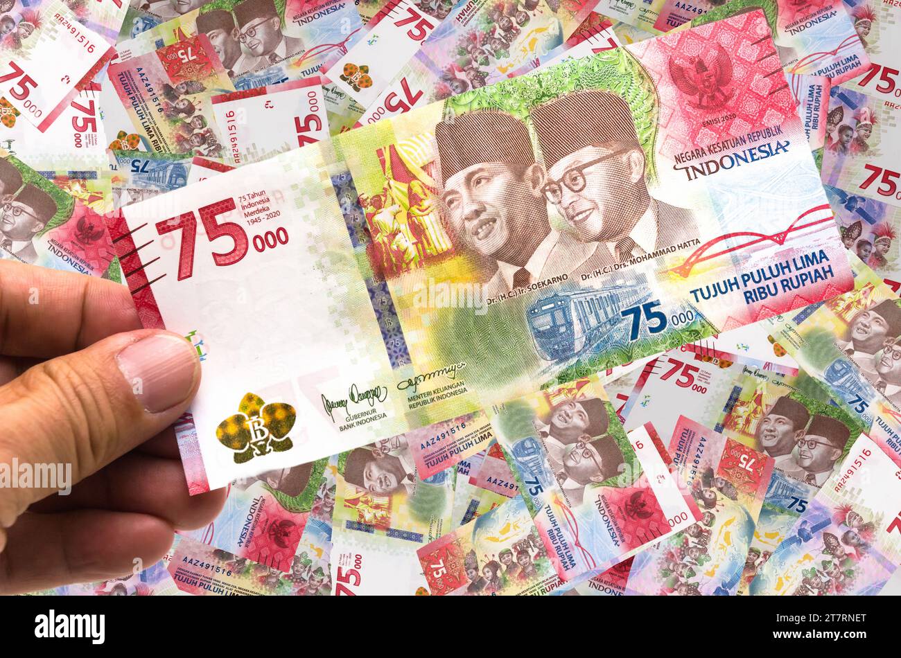 Background of 75,000 Rupiah banknotes, a group of Indonesian 75,000 ...