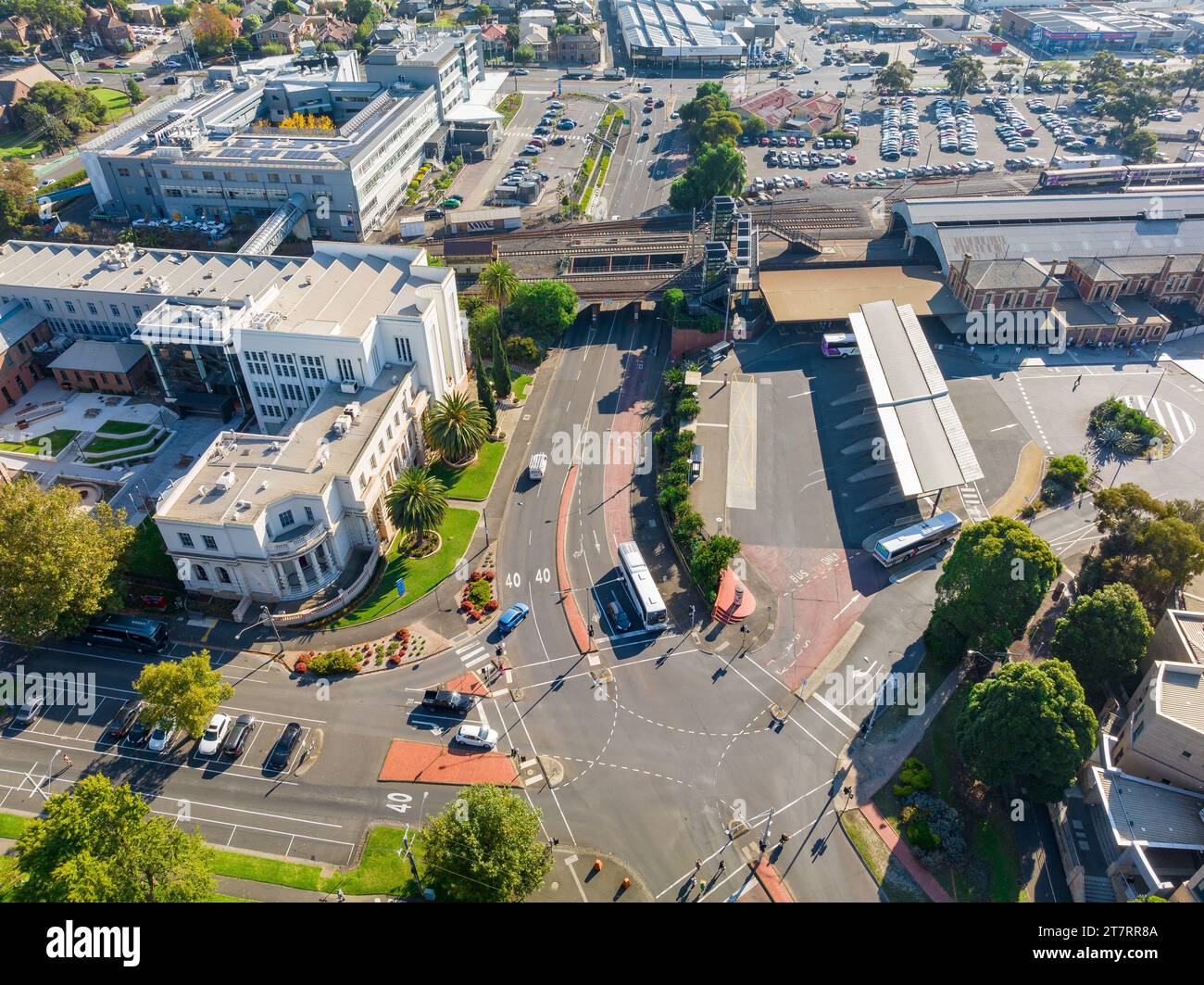 Aerial view of a busy intersection alongside a railway station ...