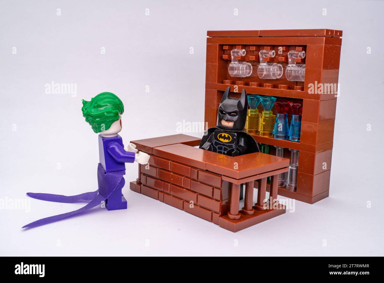 A Bar scene with lego mini figures of Batman and Joker on a white ...