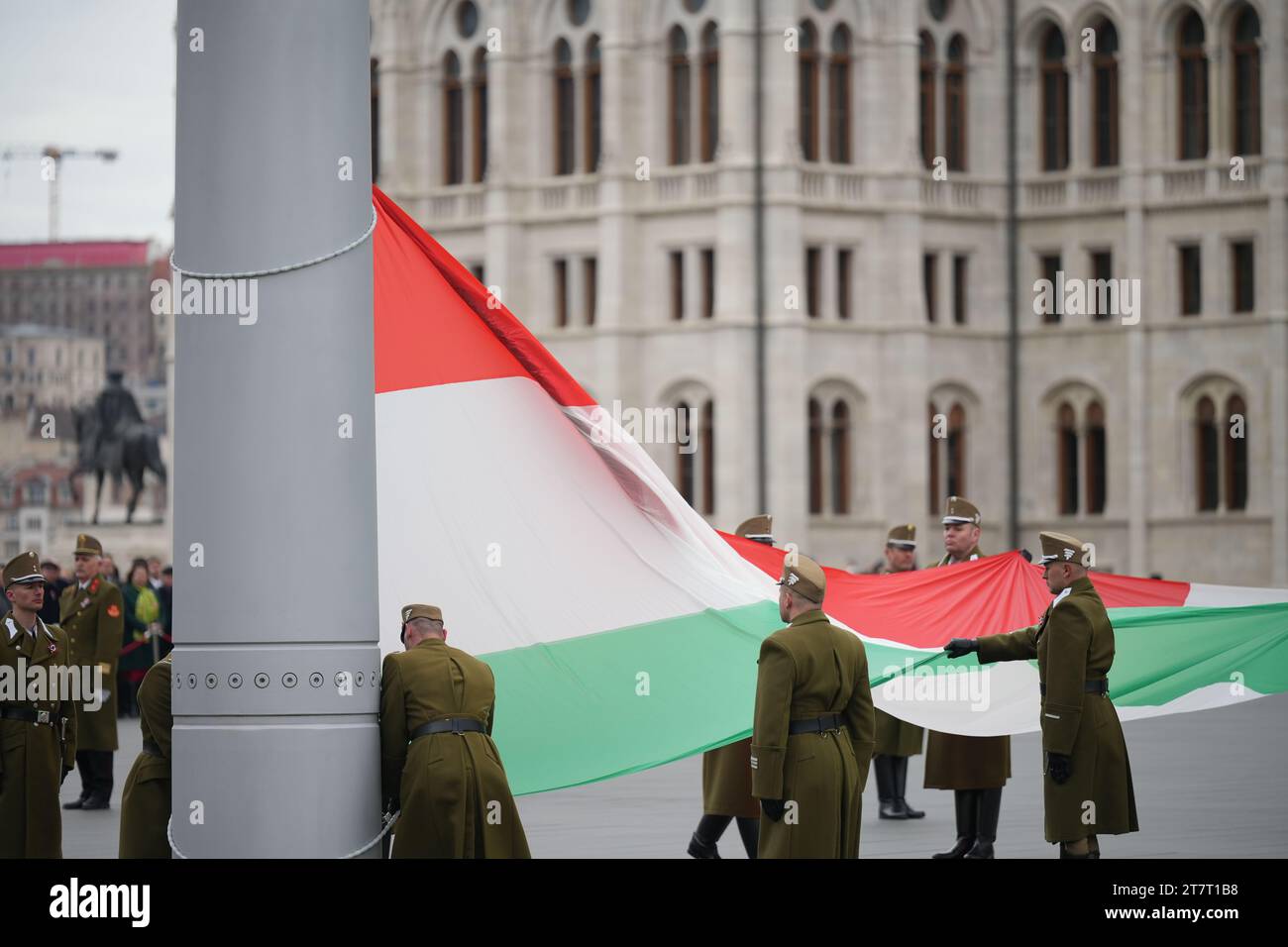 Budapest, Hungary March 15, 2023: Ceremonial raising of the Hungary flag near parliament ...