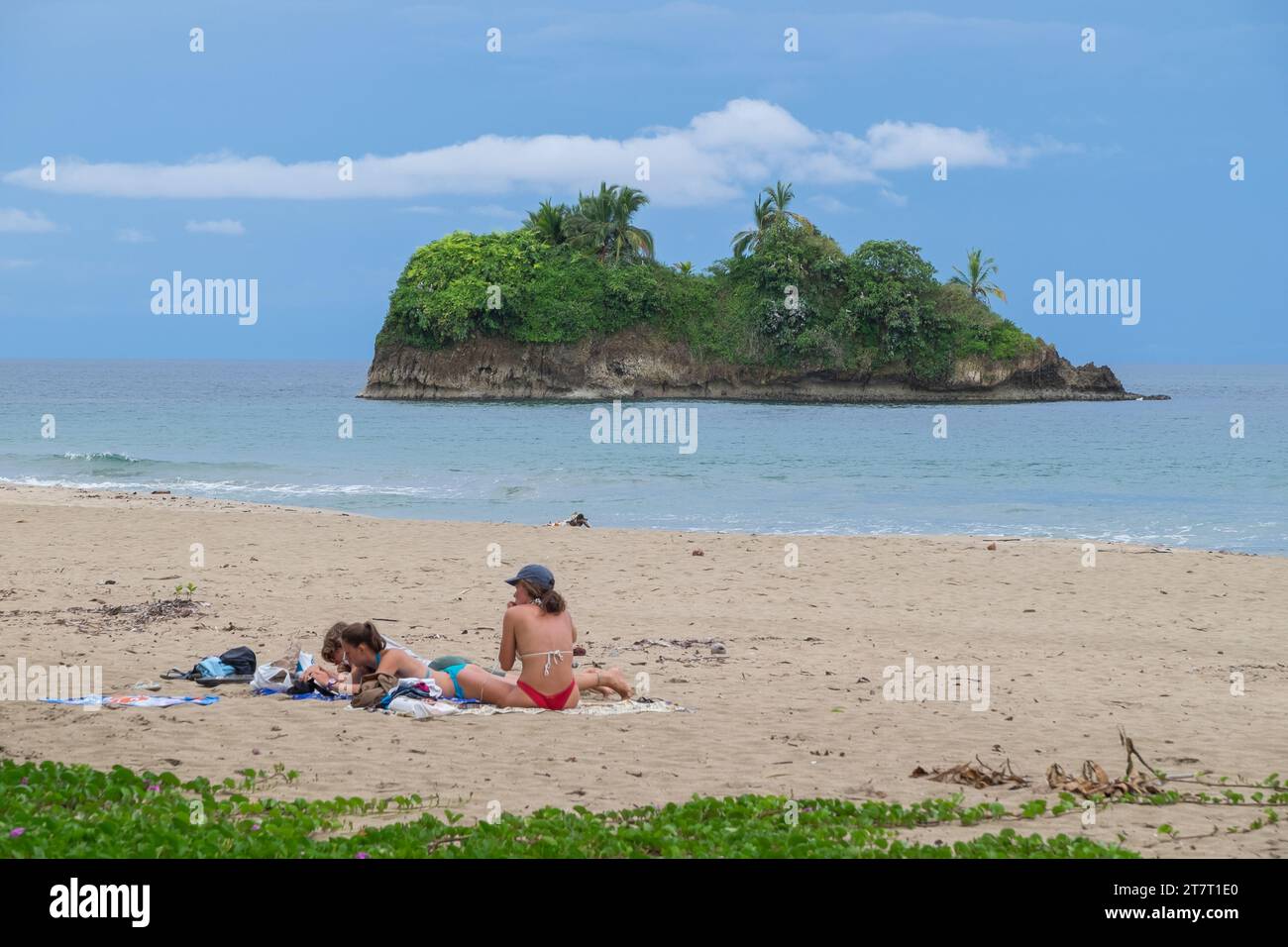 Bathers on a beach in Puerto Viejo with a view of the islet of Cocles ...