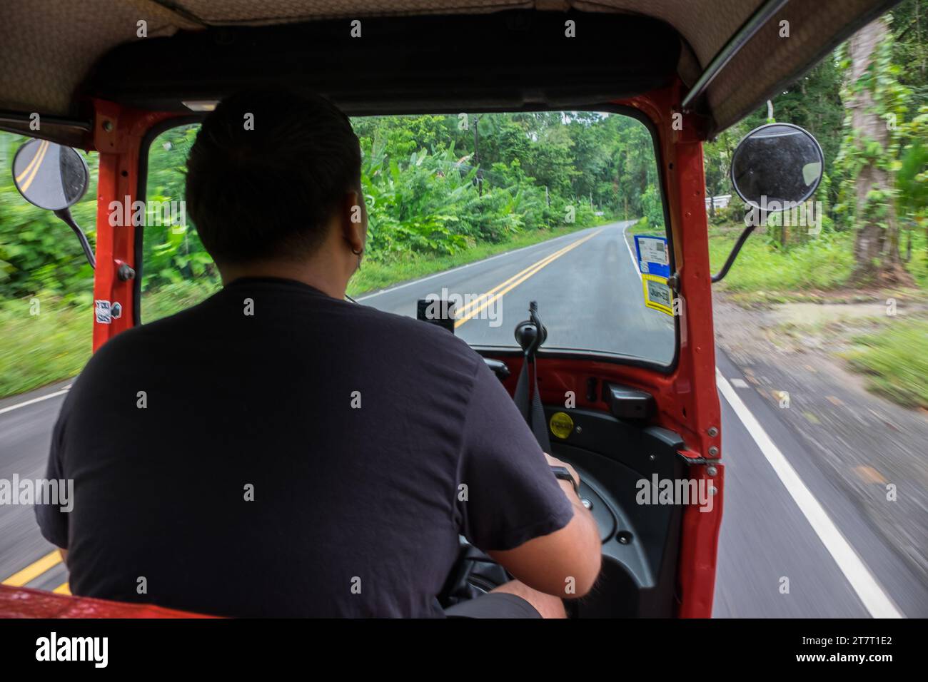 View from inside a Tuc Tuc, driving on a road in Puerto Viejo on the ...