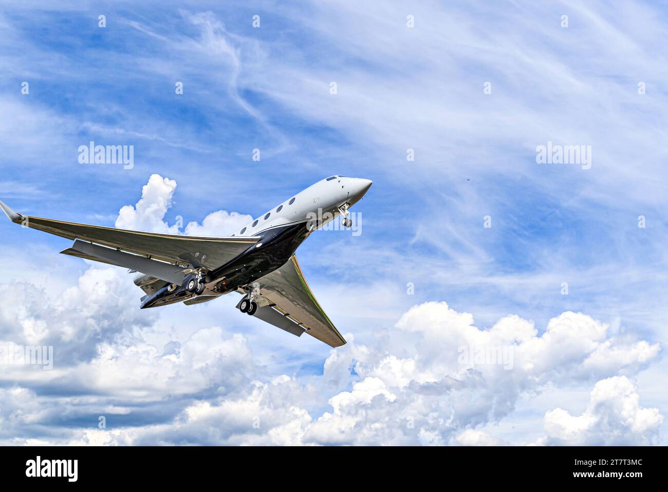 Private business plane flying under a blue sky with white clouds Stock ...