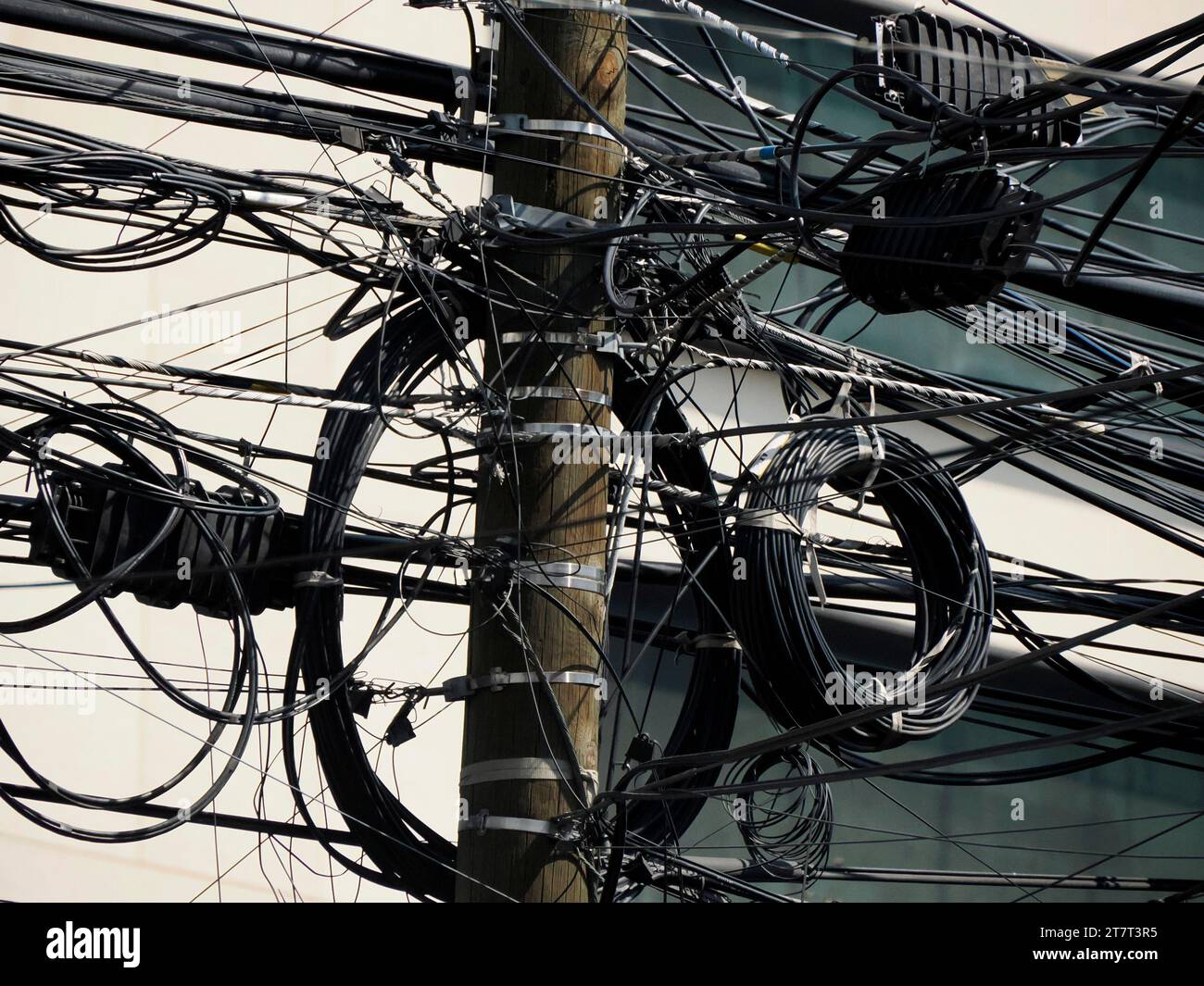 Mexico City, Messed up power lines and connection cables. Many tangled wires on electric poles ...