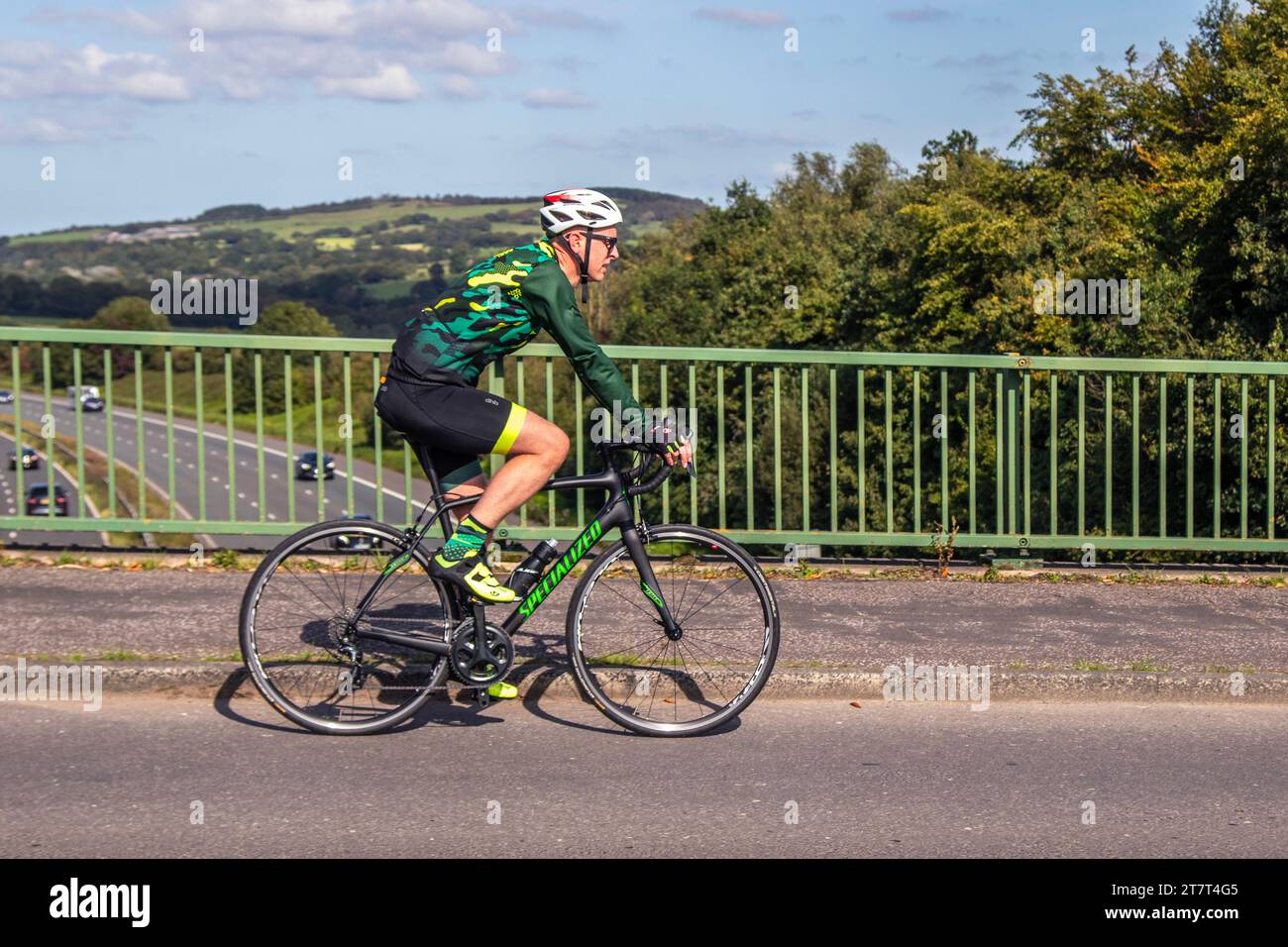 Male cyclist riding Specialized carbon fibre sports road bike on ...