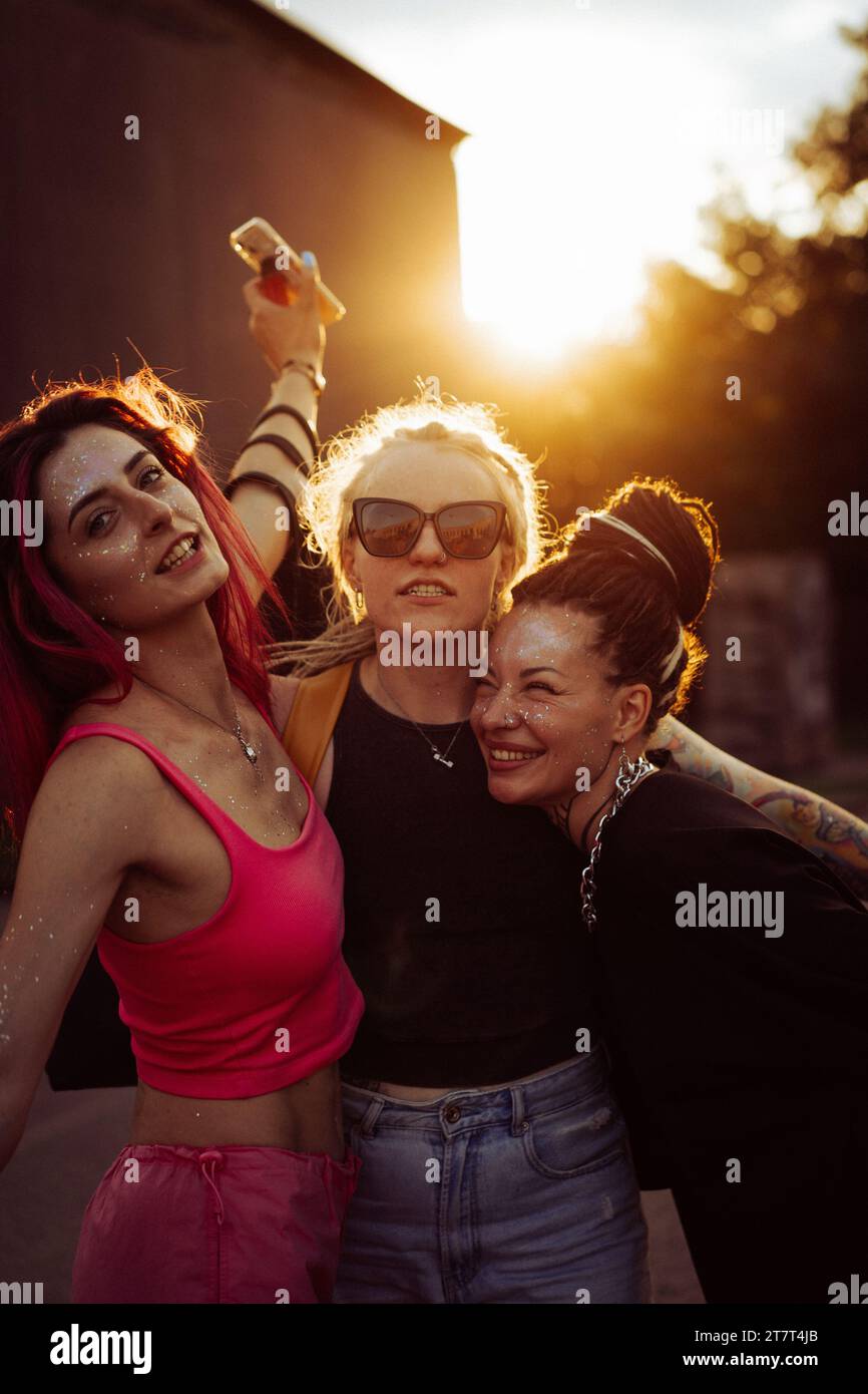 Three happy women friends at sunset, emotional portrait, friendship ...