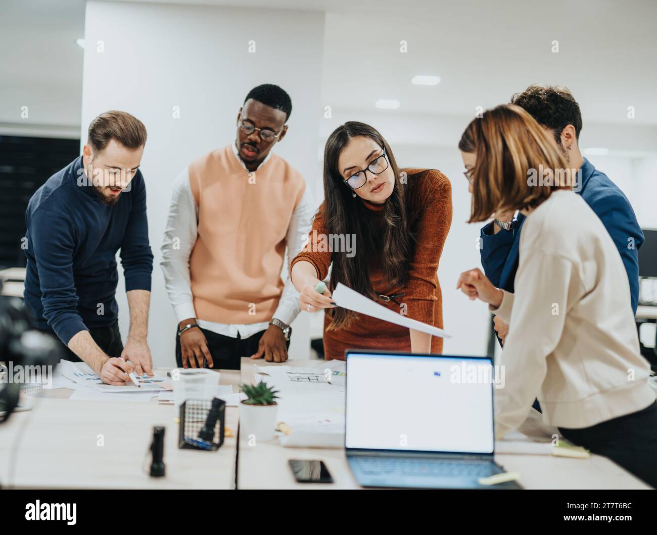 Corporate Team Analyzing Reports for Business Growth Stock Photo - Alamy