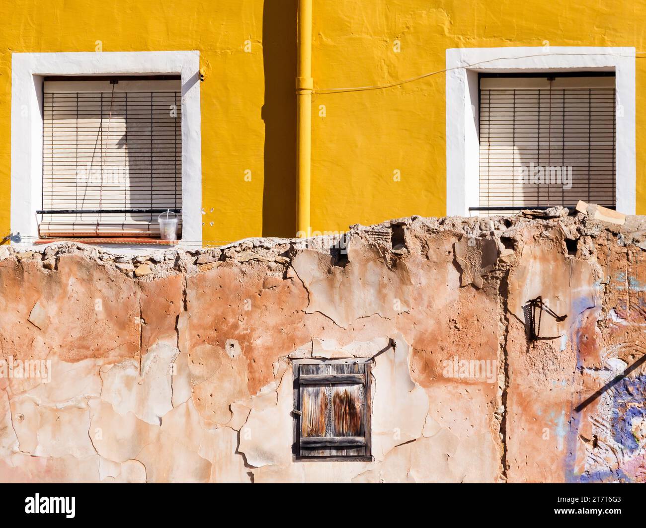 Old small window in front of yellow facade Stock Photo - Alamy