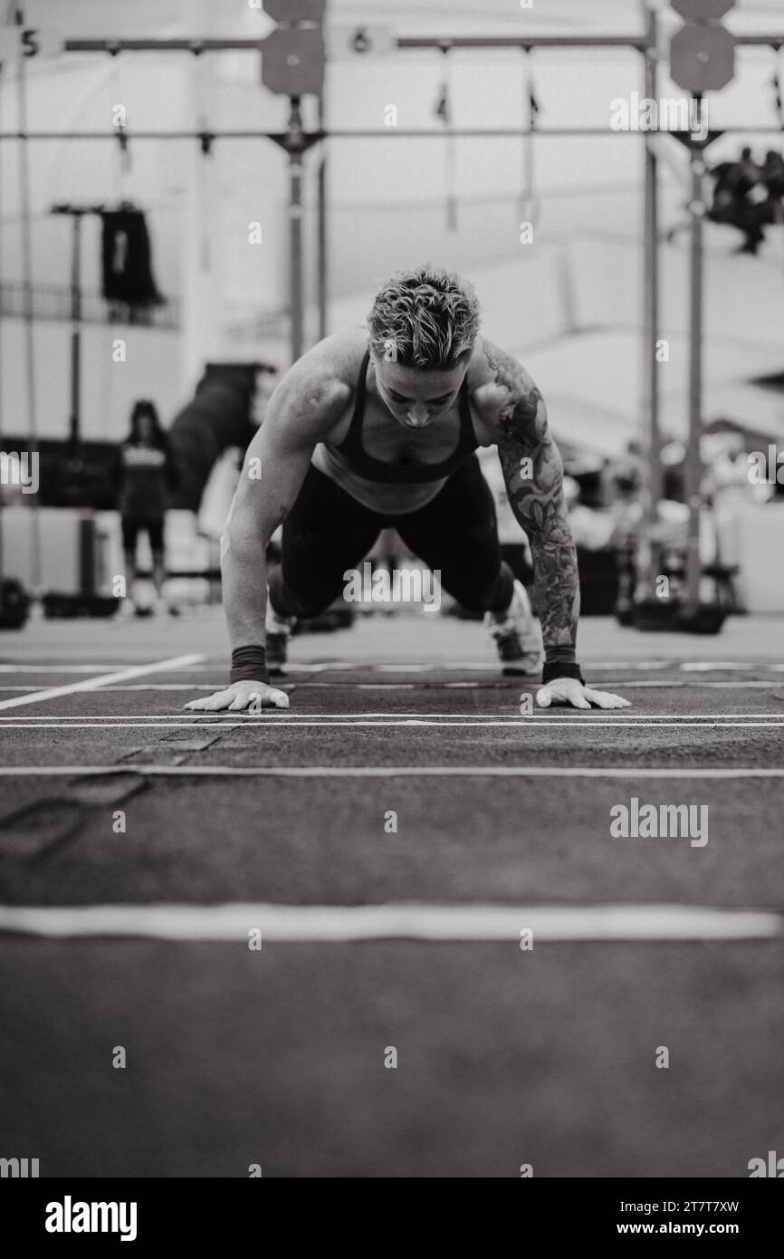 A woman does burpees and push-ups at a CrossFit competition Stock Photo ...