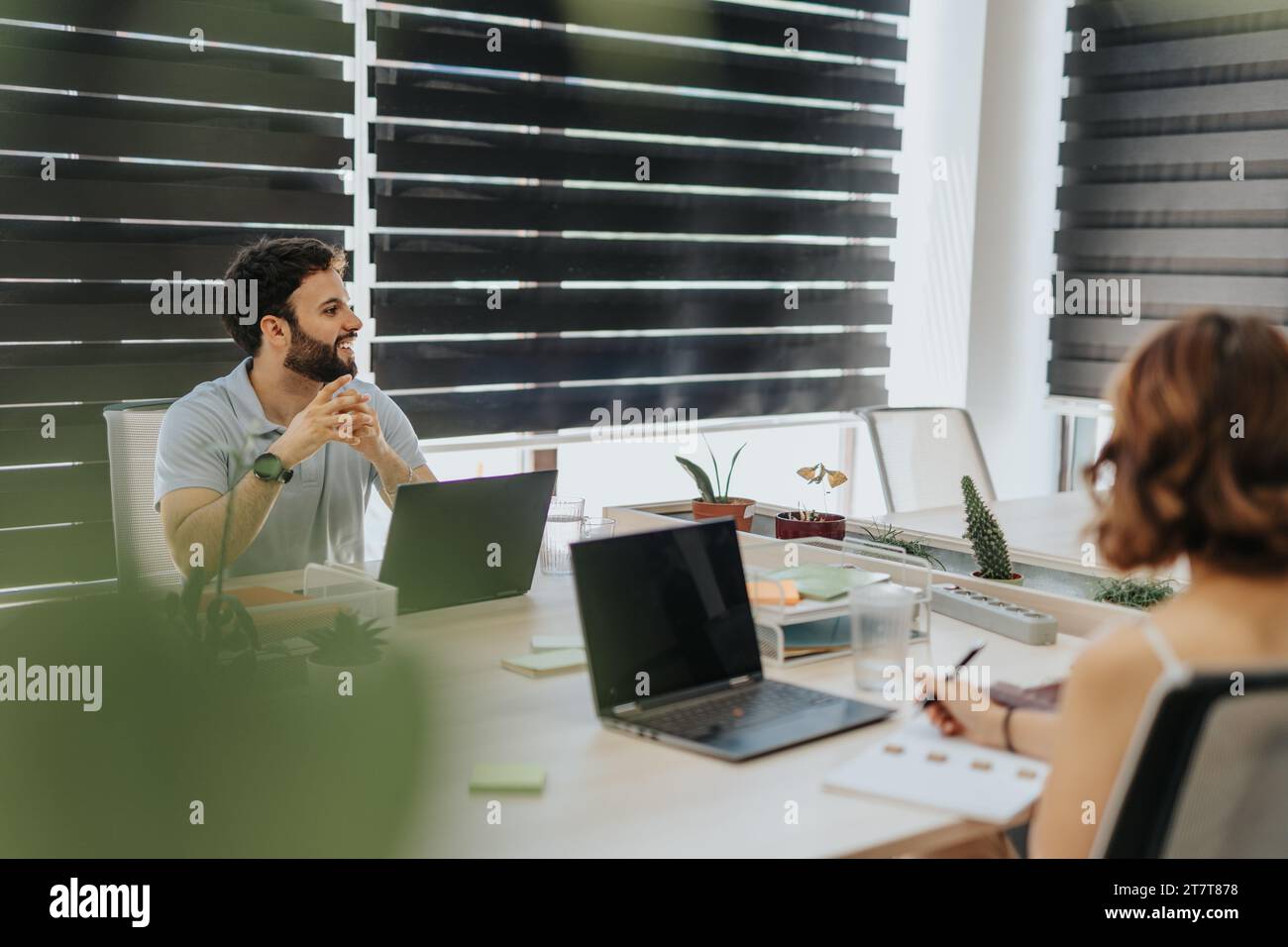 Happy, smiley, male business person having a conversation with his ...