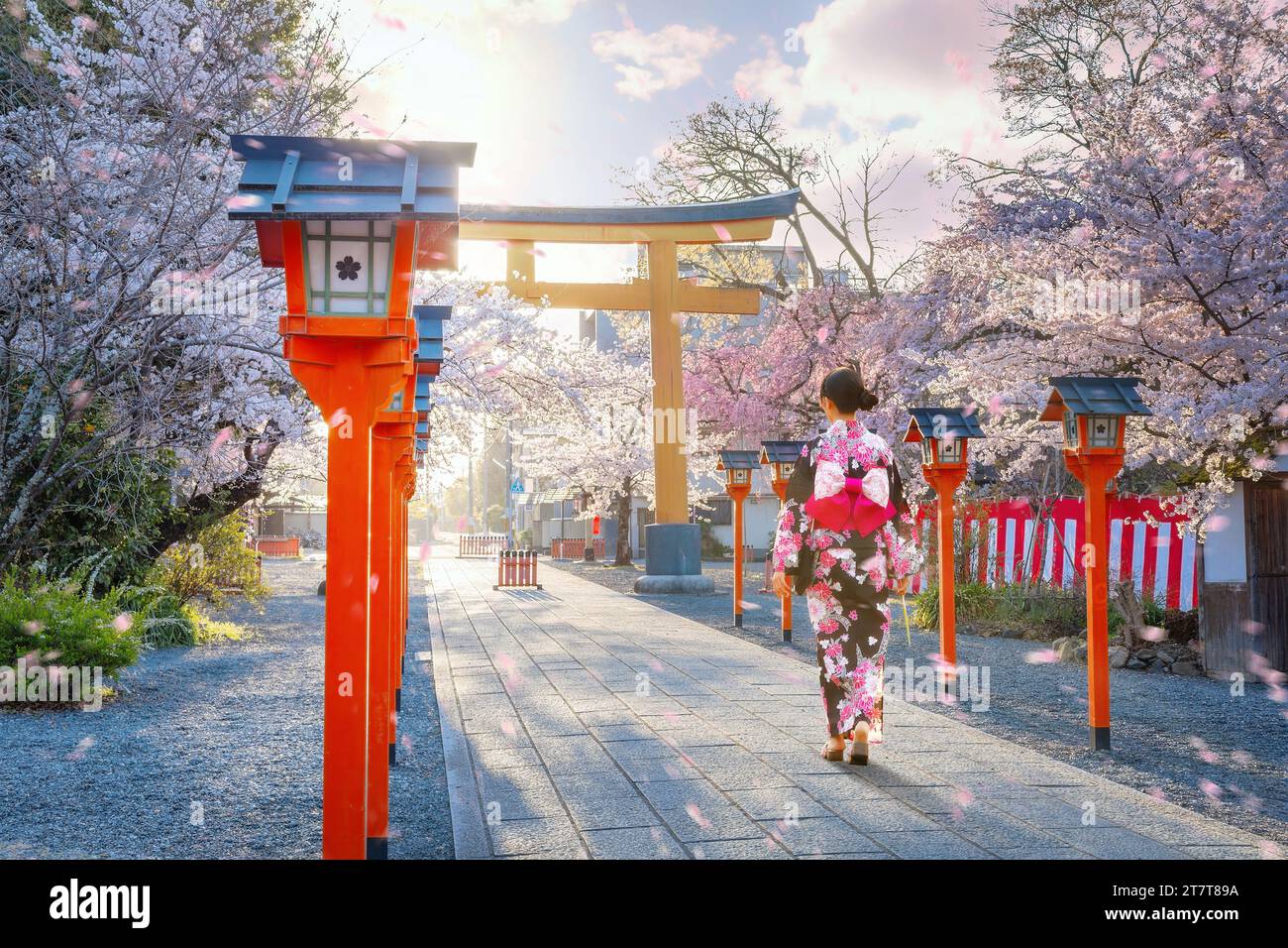 Young Japanese woman in traditional Yukata dress strolls at Hirano ...